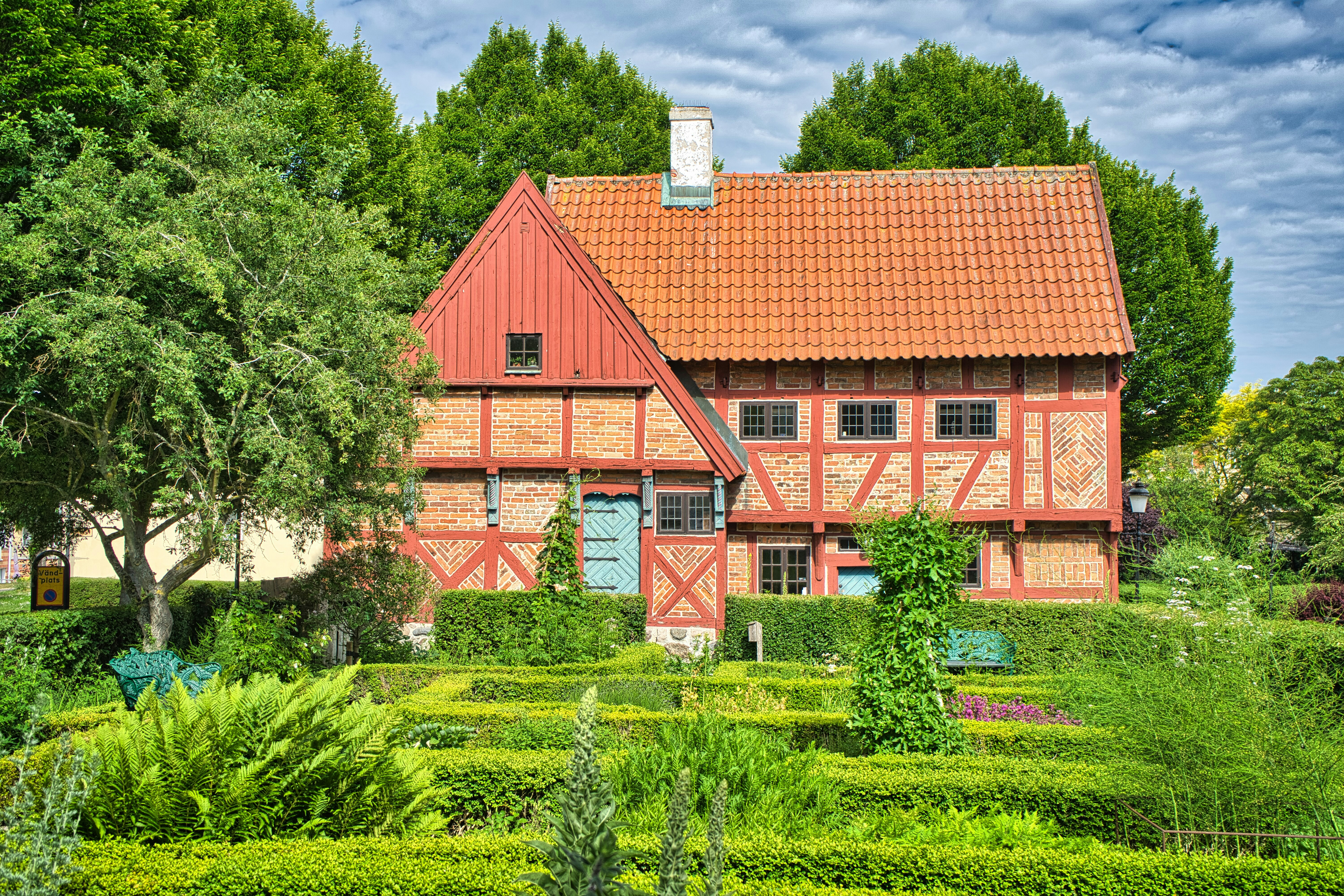 Timber-Framed Manor Amid Pruned Parterres