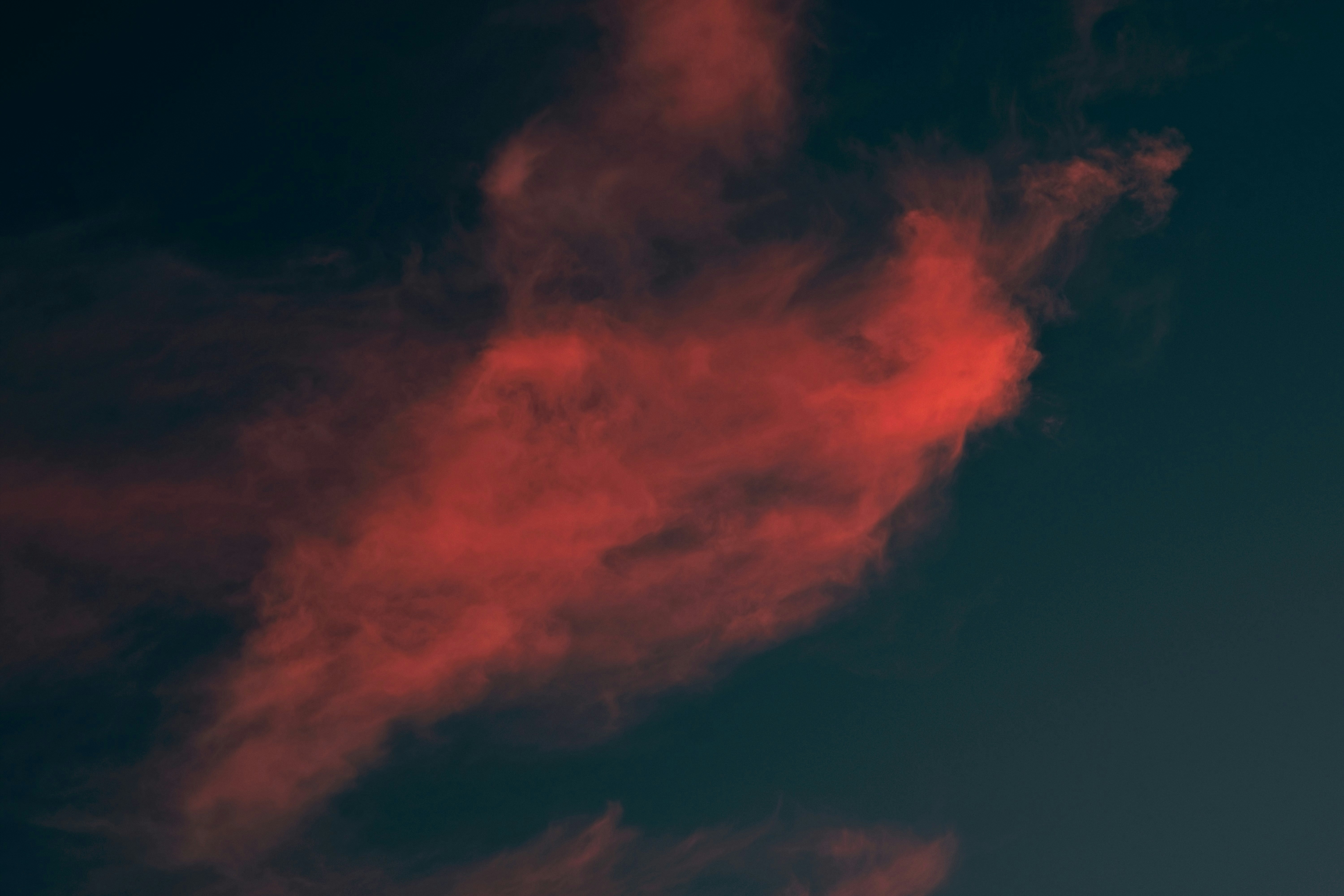 Red-tinged Cloud Ribbon Crossing a Dusky Sky