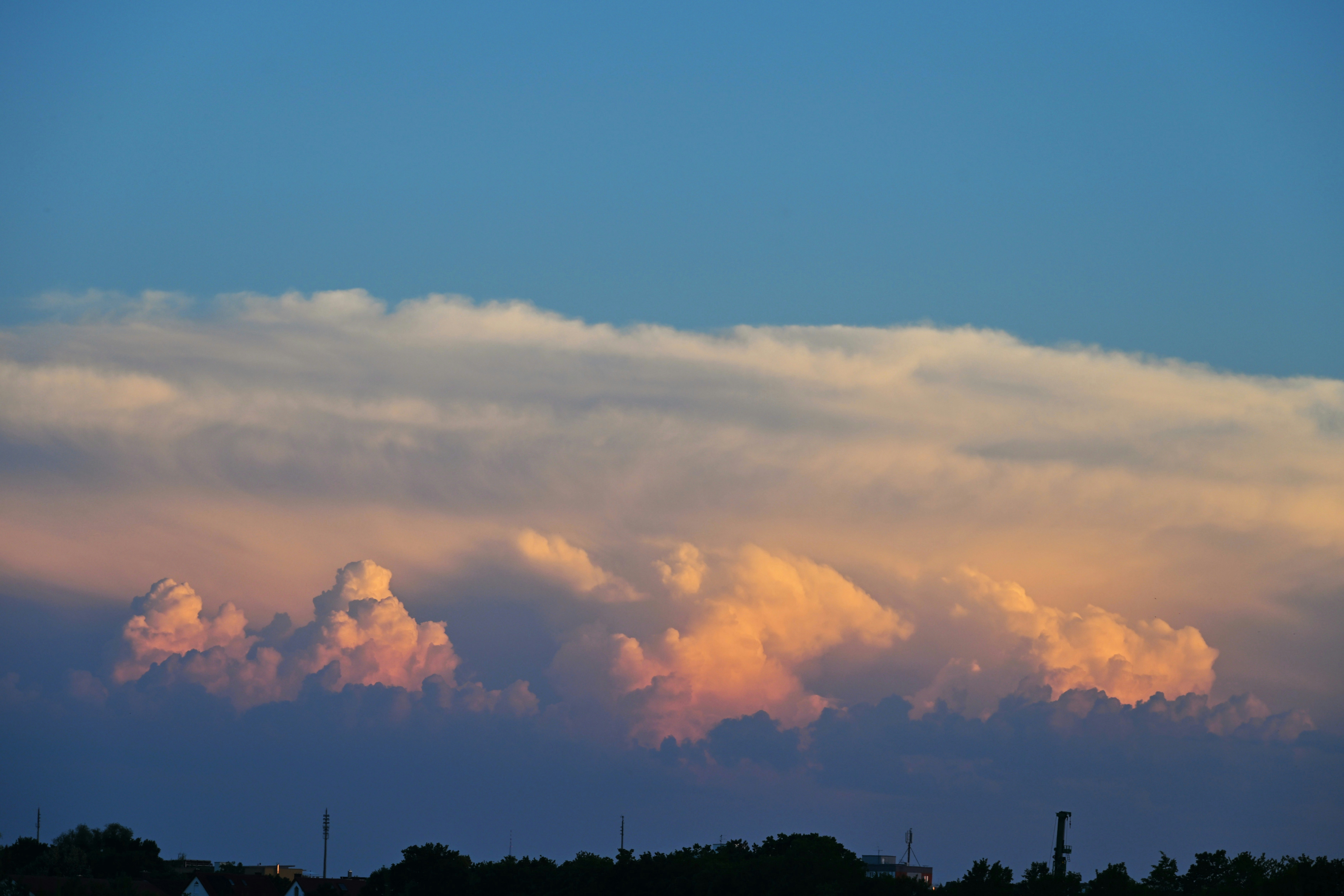 Sunlit Cloudscape Above a Quiet Horizon