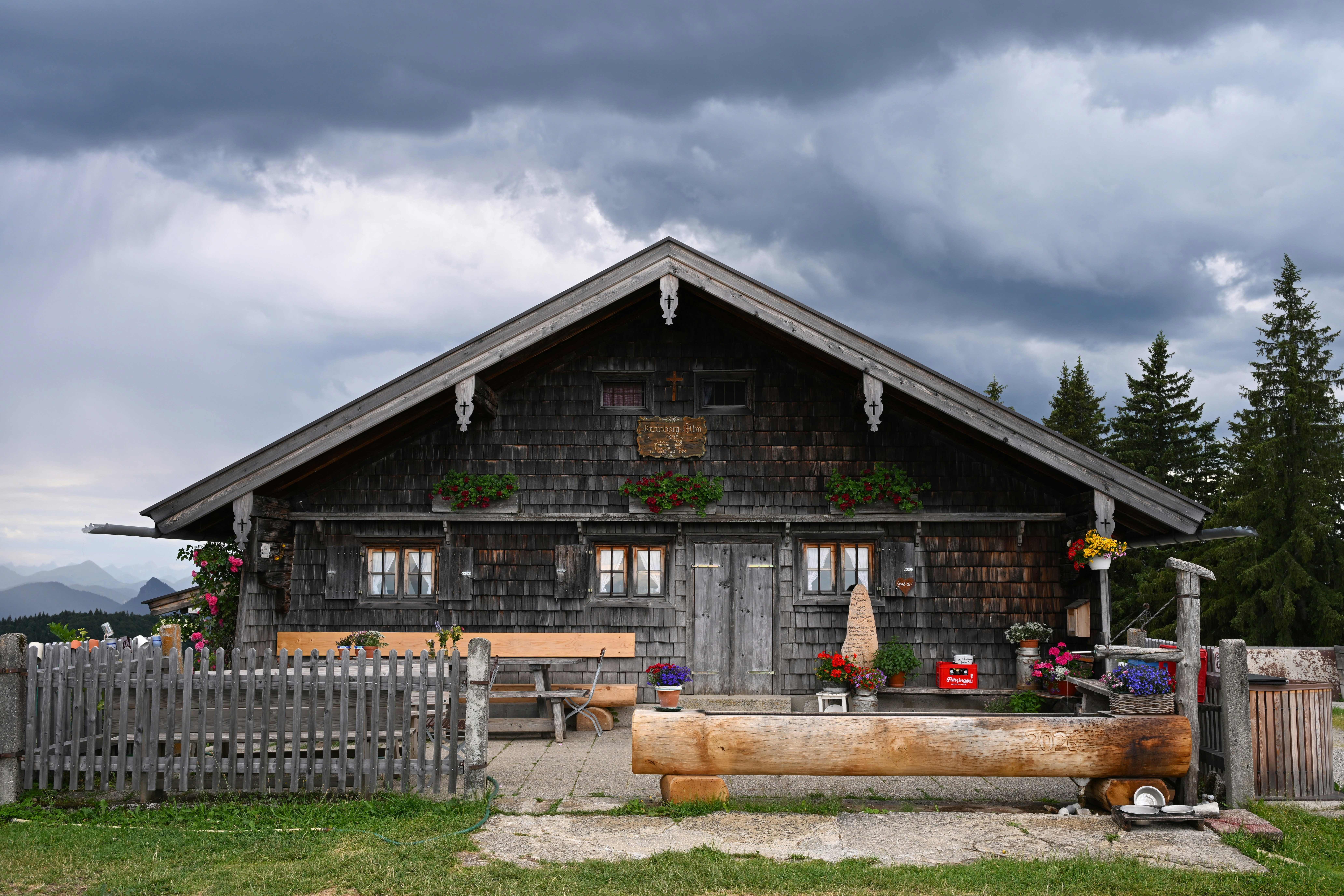 Alpine Chalet Shelter: Weathered wood with a colorful frontier garden