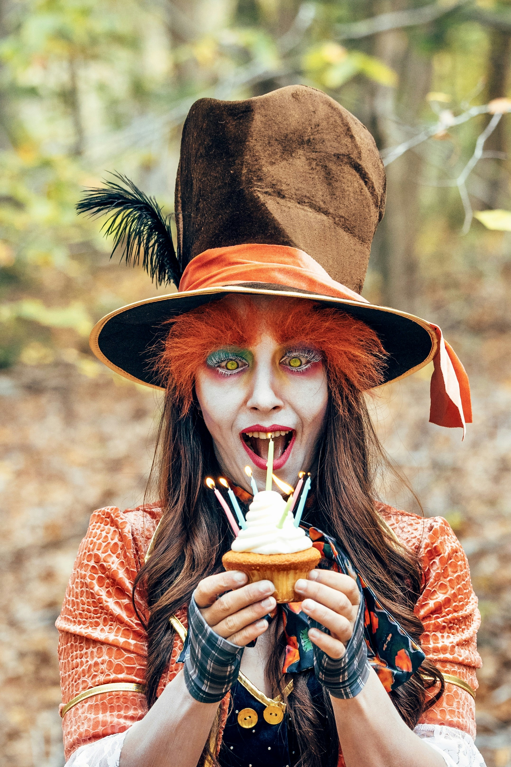Whimsical Birthday Gaze: A Festive Hat, Candy Frosting, and Bold Orange Feathers