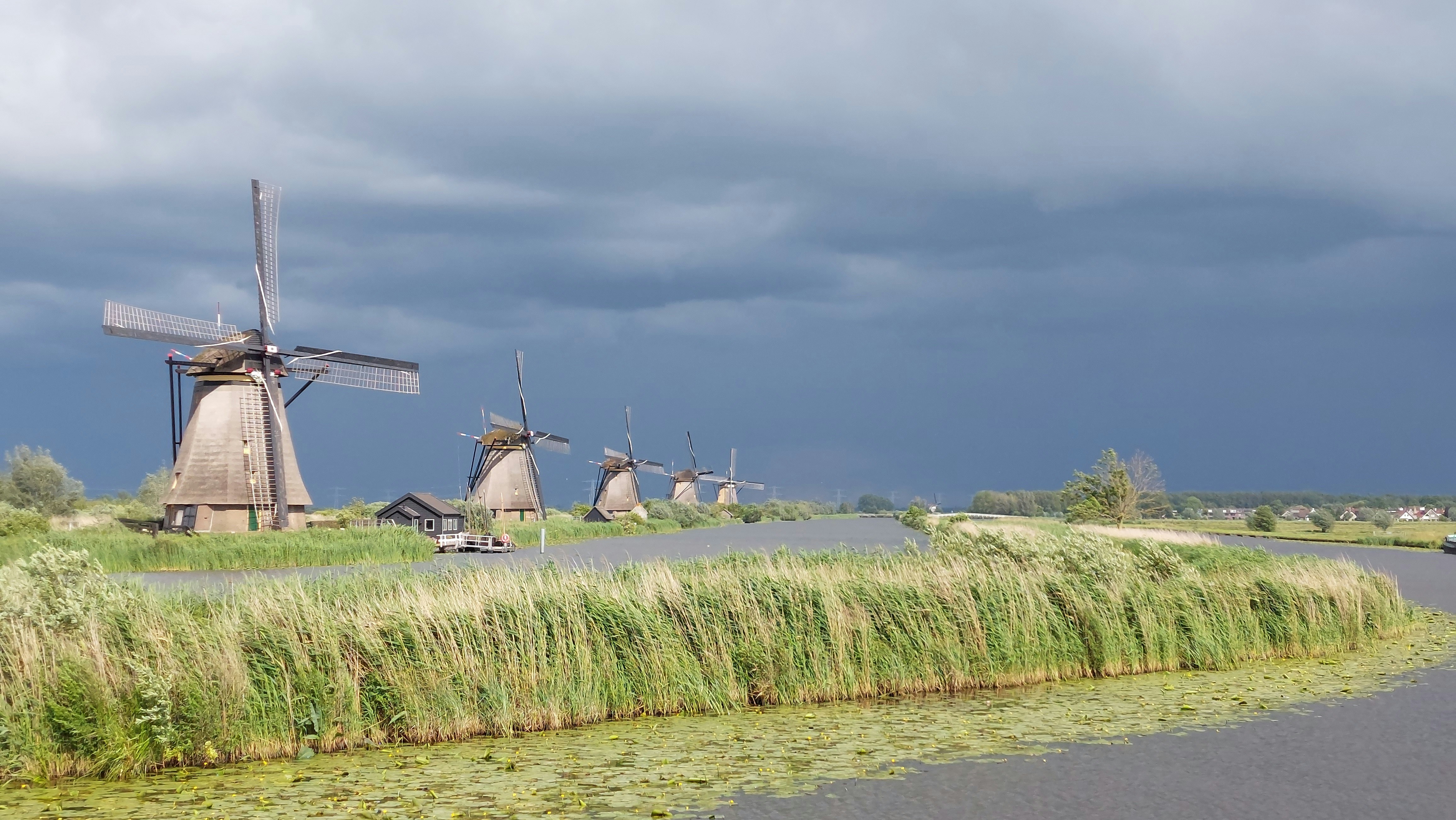 Dutch Windmills along a Reclaimed Canal at Stormy Dusk