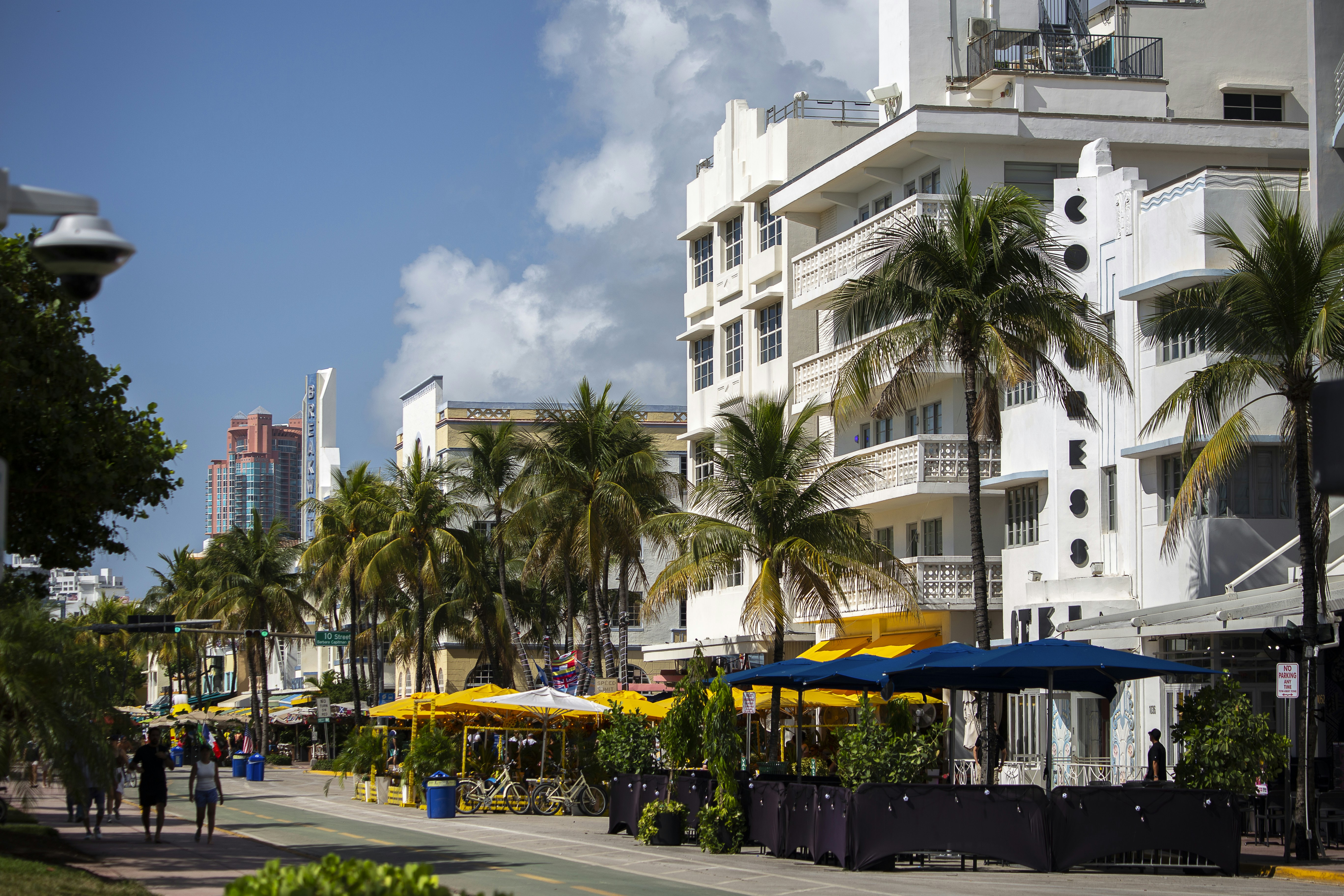 Sunlit Oceanfront Street with Colorful Café Umbrellas