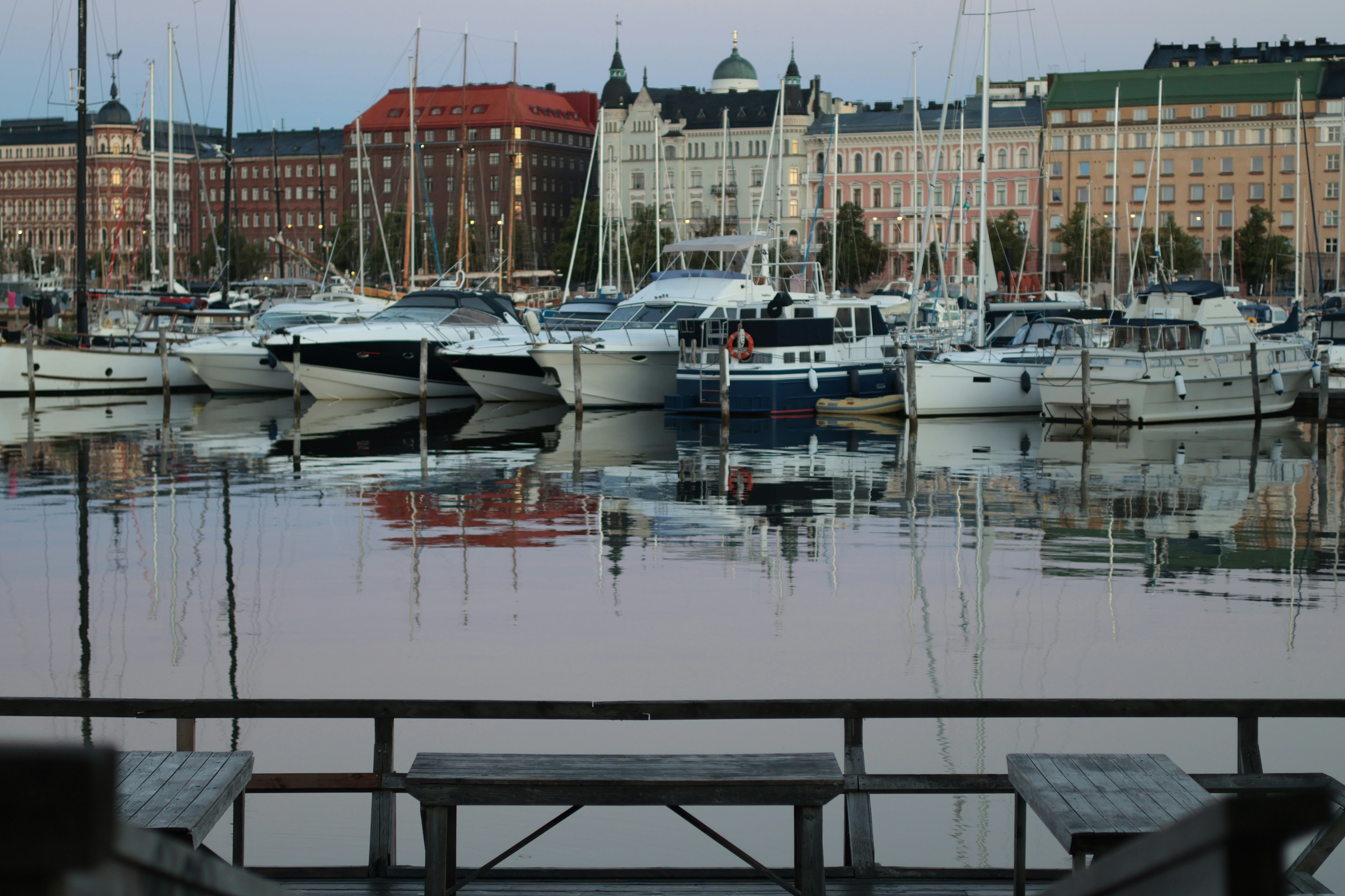 Harbor of Reflections: Boats and Cityscape at Dusk