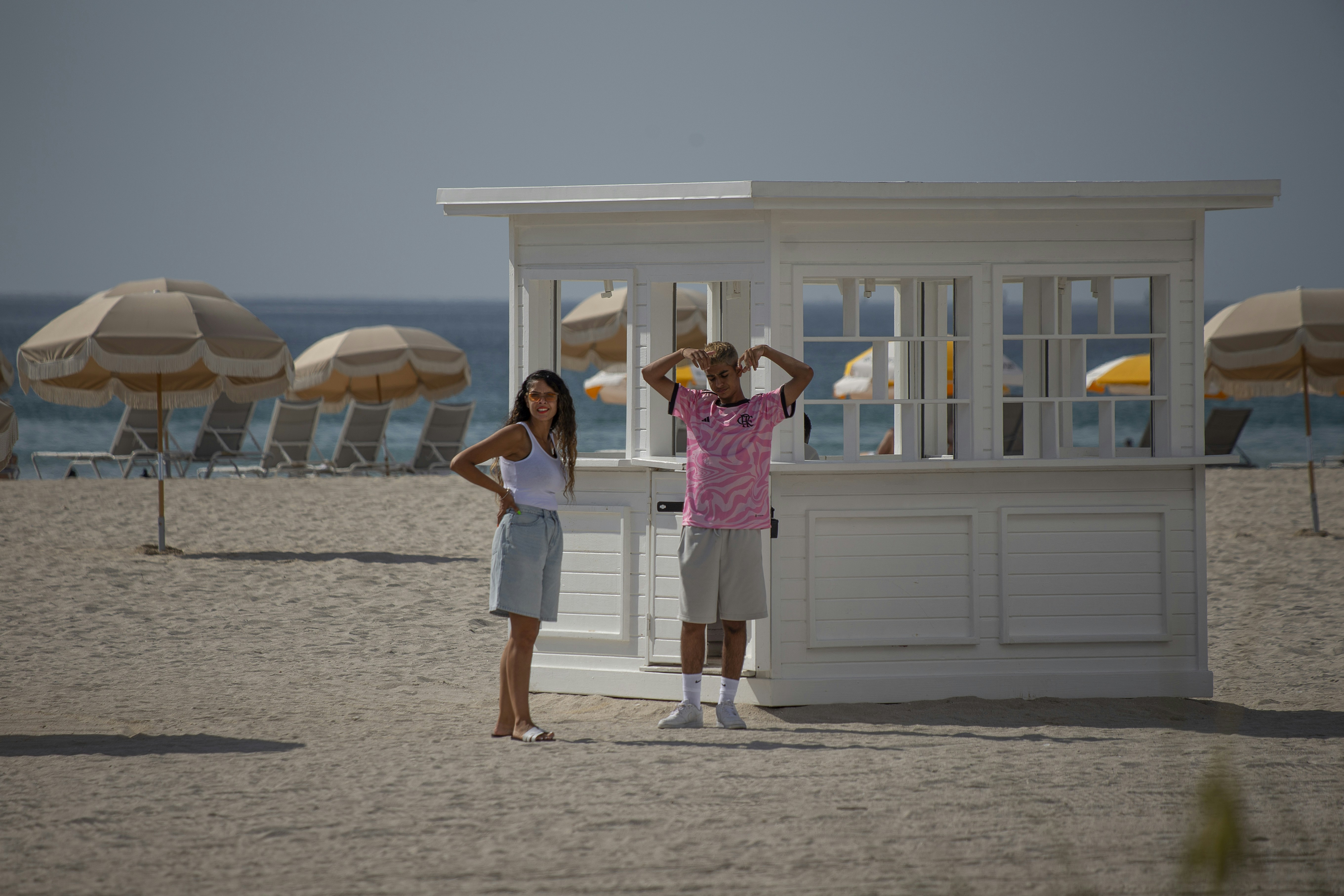 Beachside Lifeguard Duo at Noon: Aligned with a Quiet Sandfront