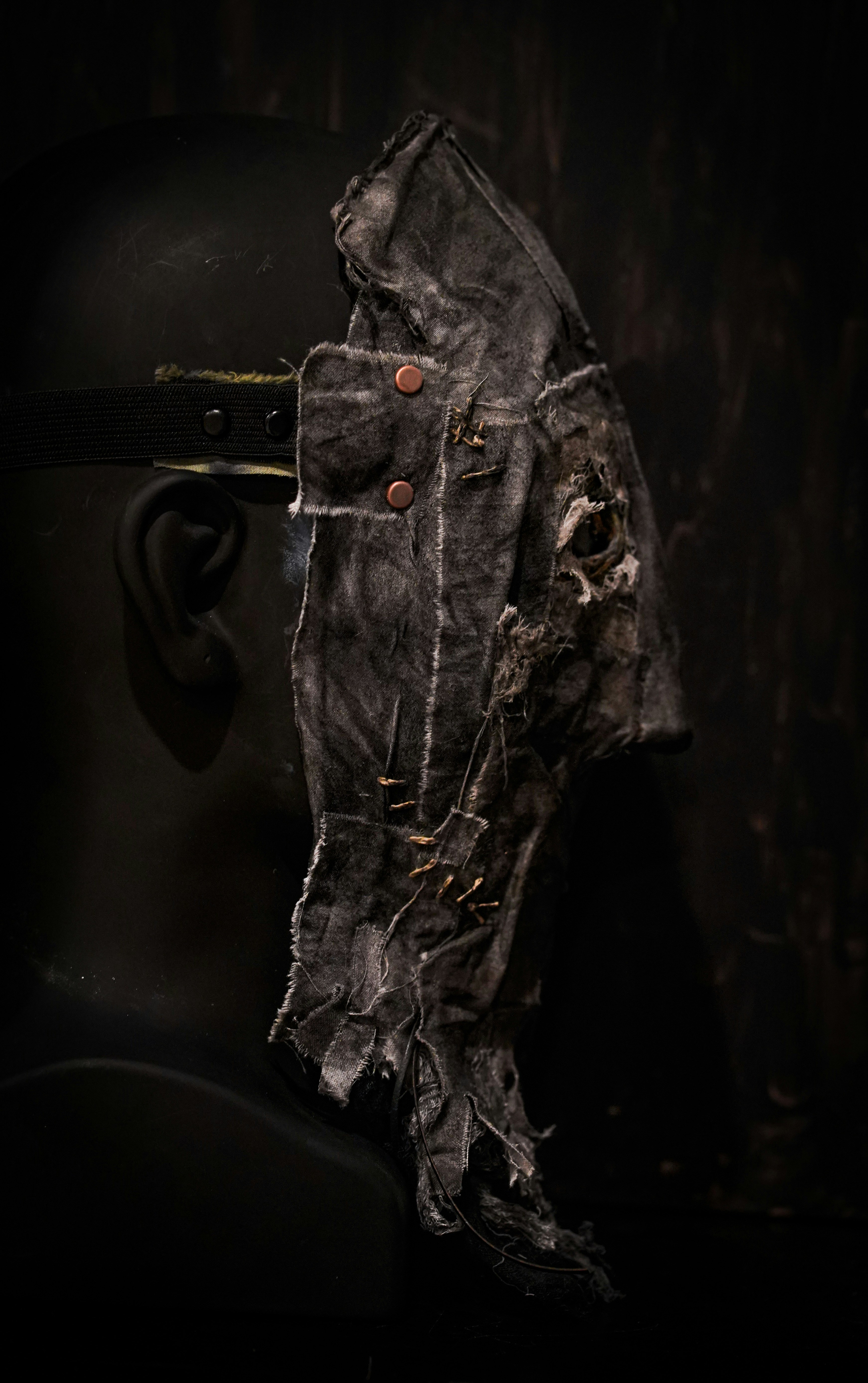 Rugged Fabric on a Silent Mask: A Portrait of Decay