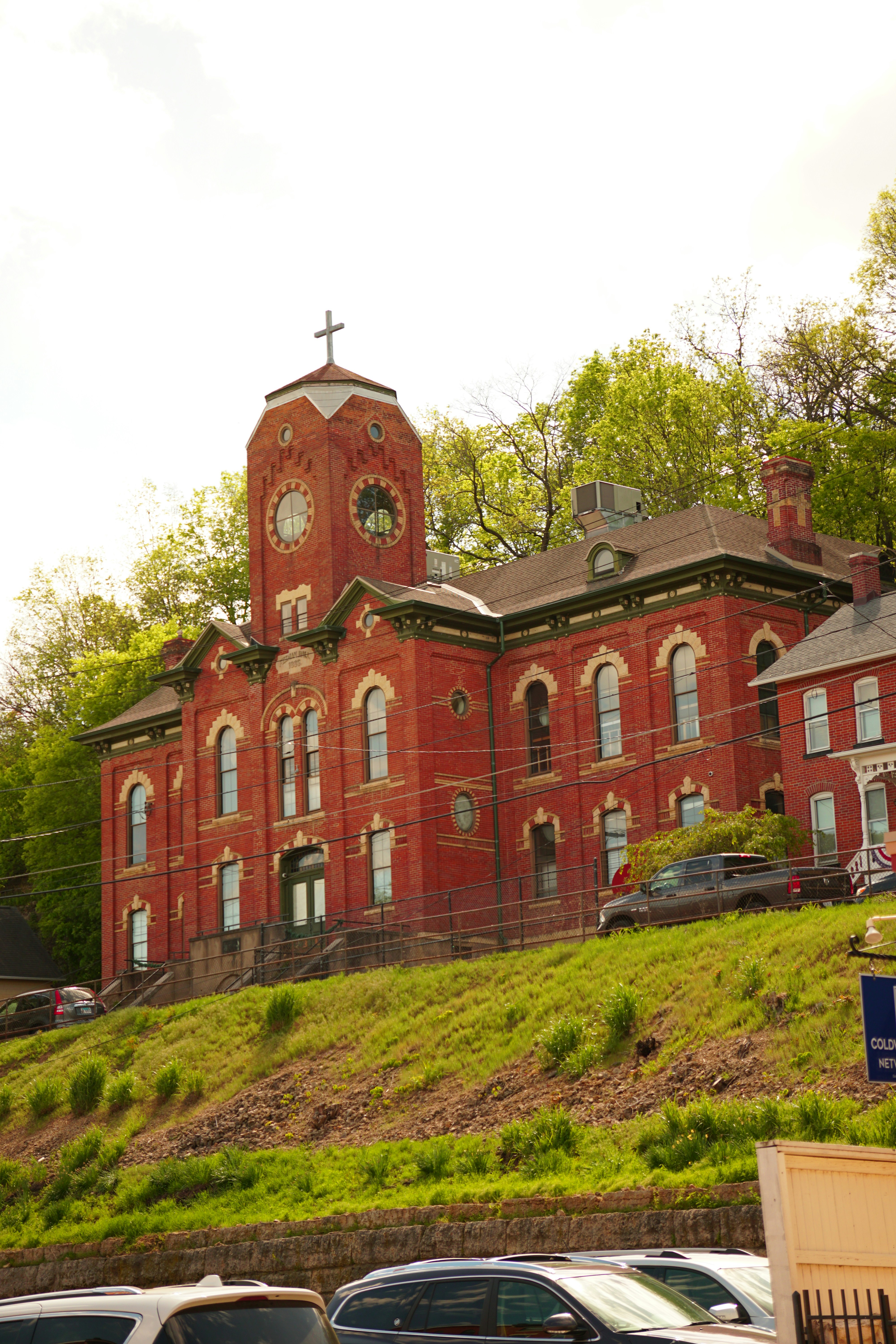 Red Brick Clocktower Hall under Spring Greenery