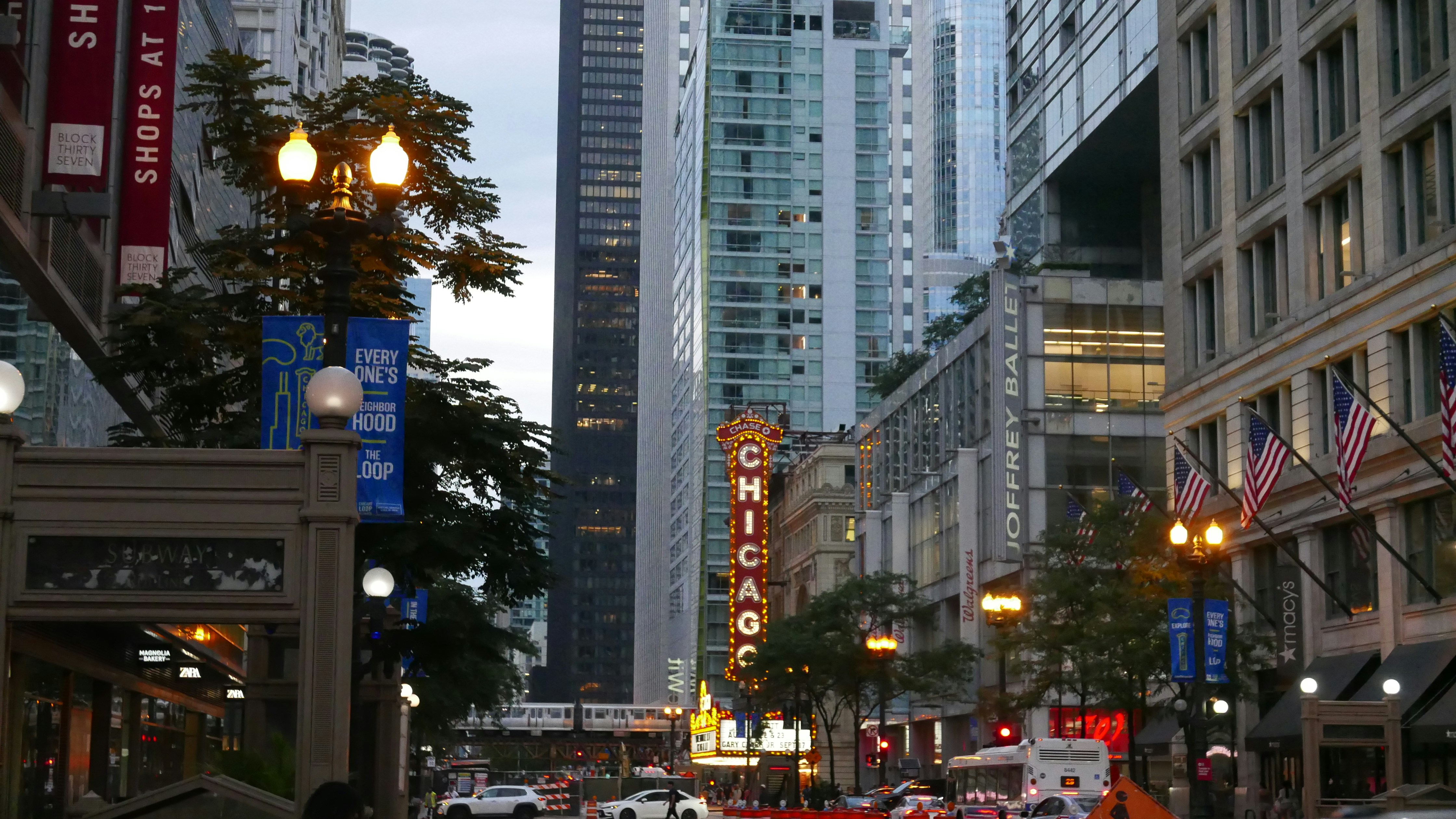 City Clock: Neon Signage Amid Skyscrapers at Dusk