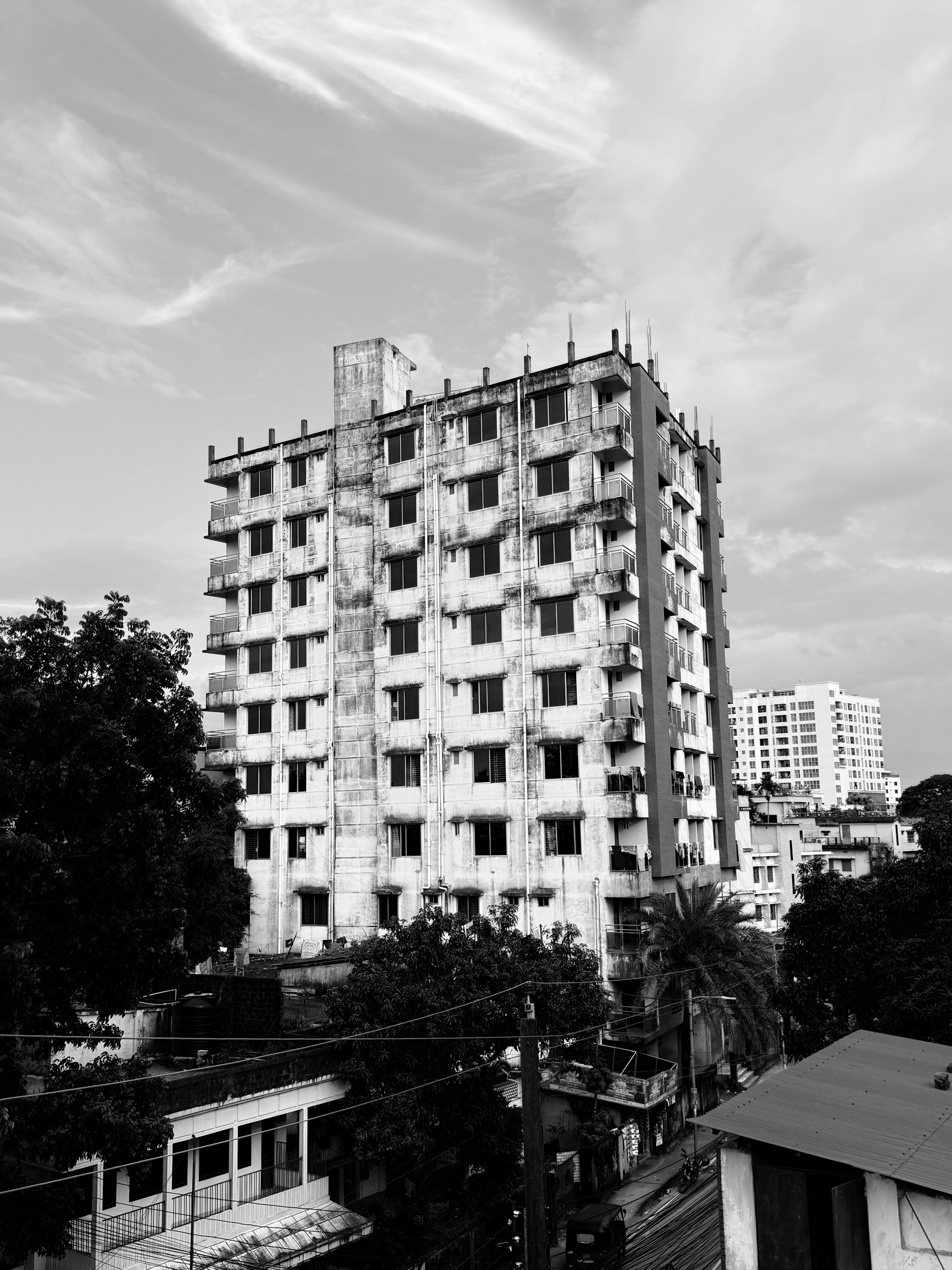 Weathered Highrise Above a Quiet Urban Veil