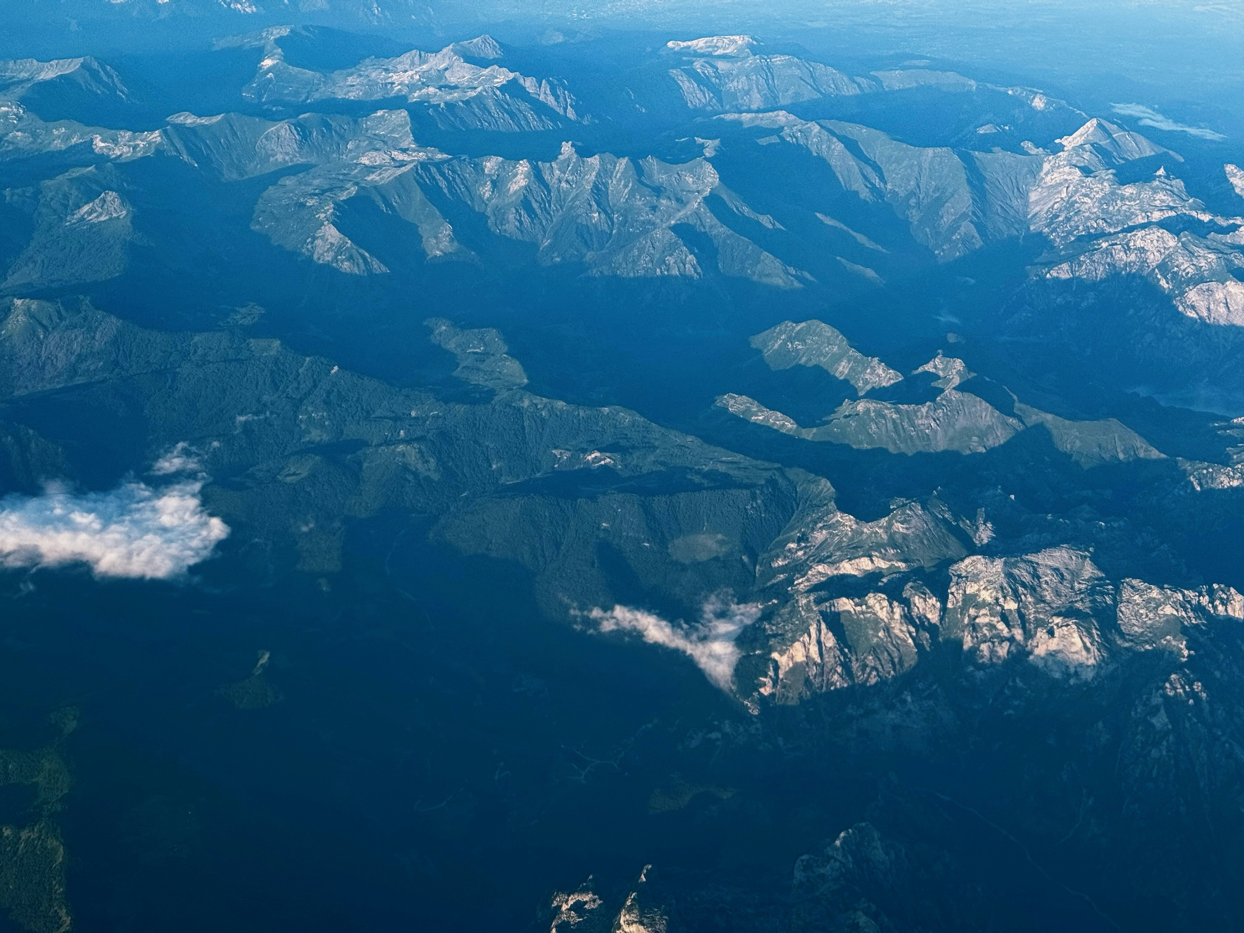 Aerial Tapestry: Moonlit Peaks from the Dawn Ridge