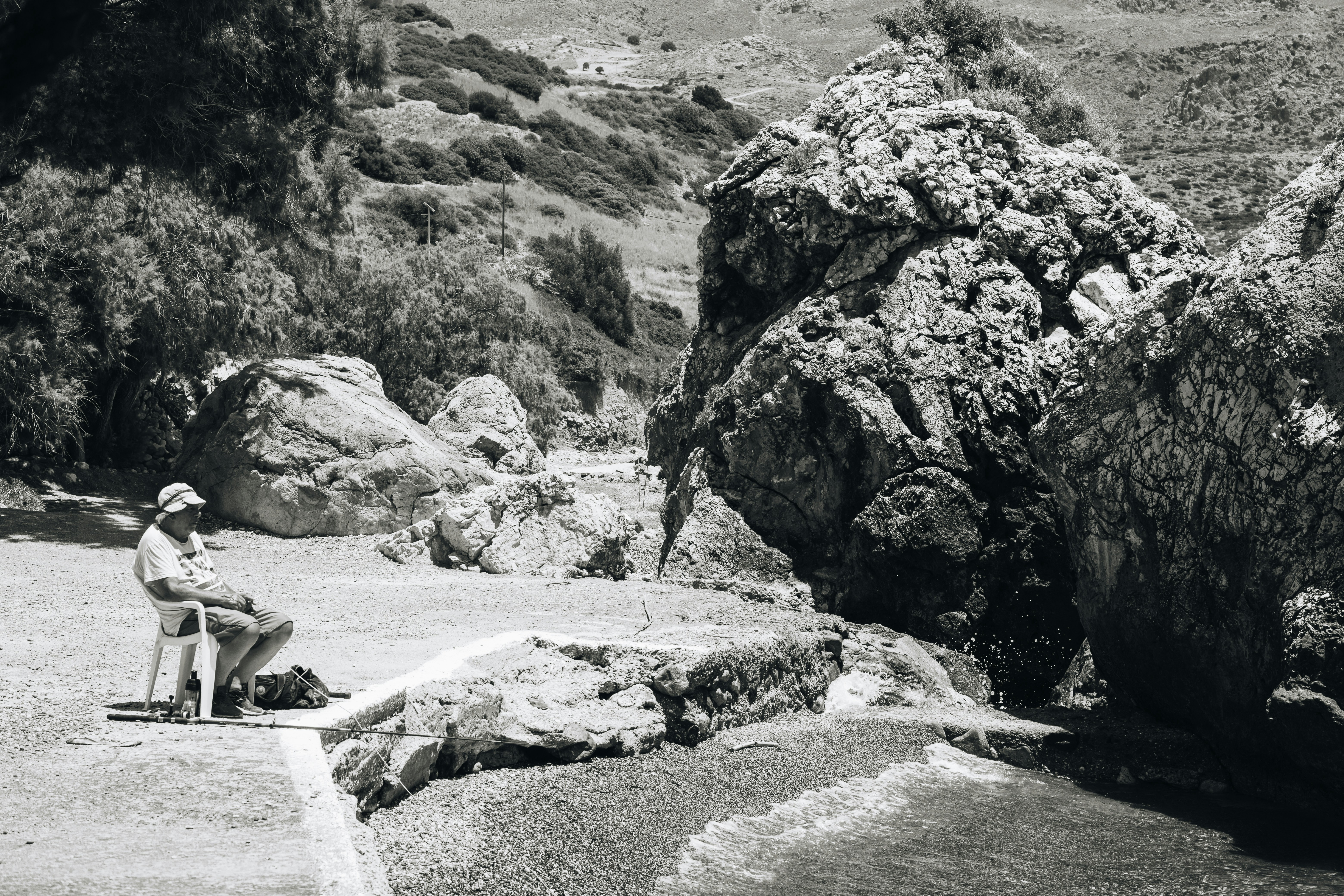 A Quiet Shoreline Watch: Angler by the Rocks