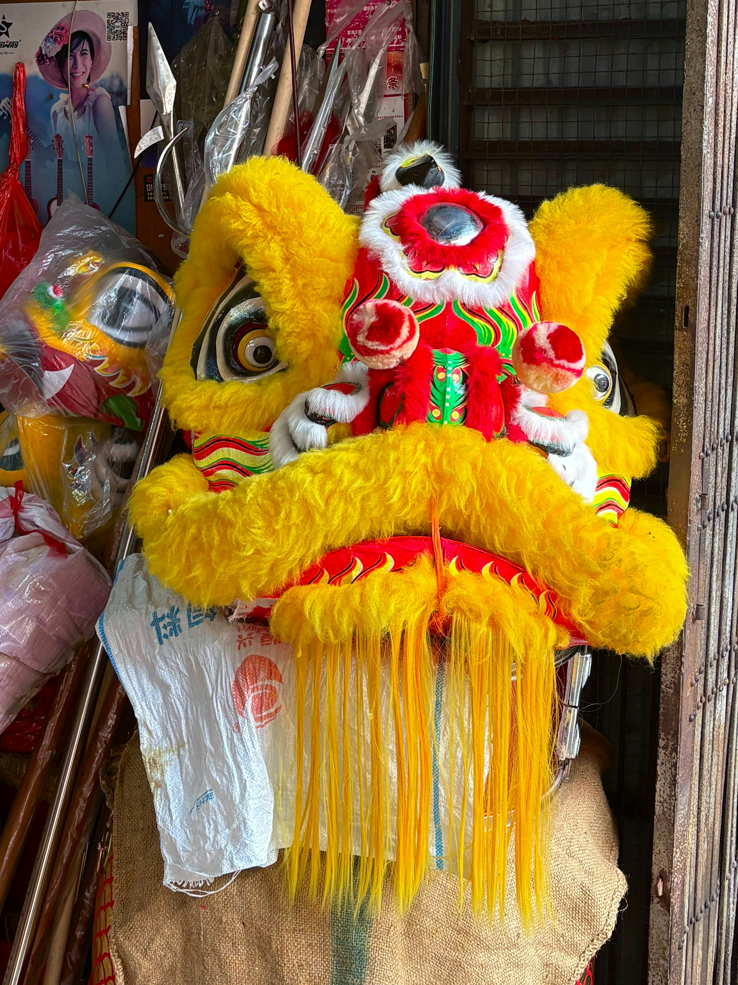 Vibrant Yellow Lion Mask Amid Hidden Storefront Props