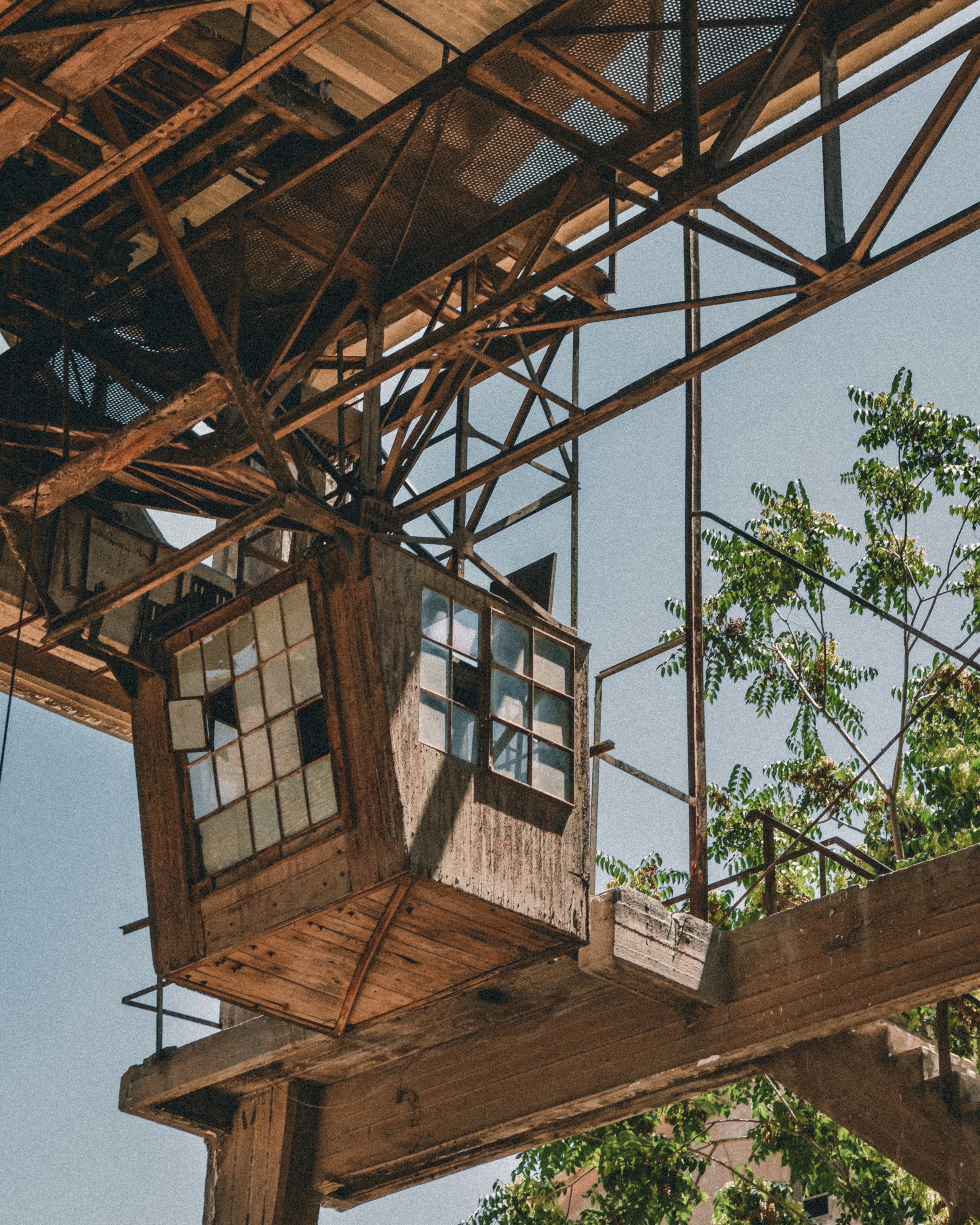 Rusty Gondola over Steel and Wood: A Distant Lift into Decay