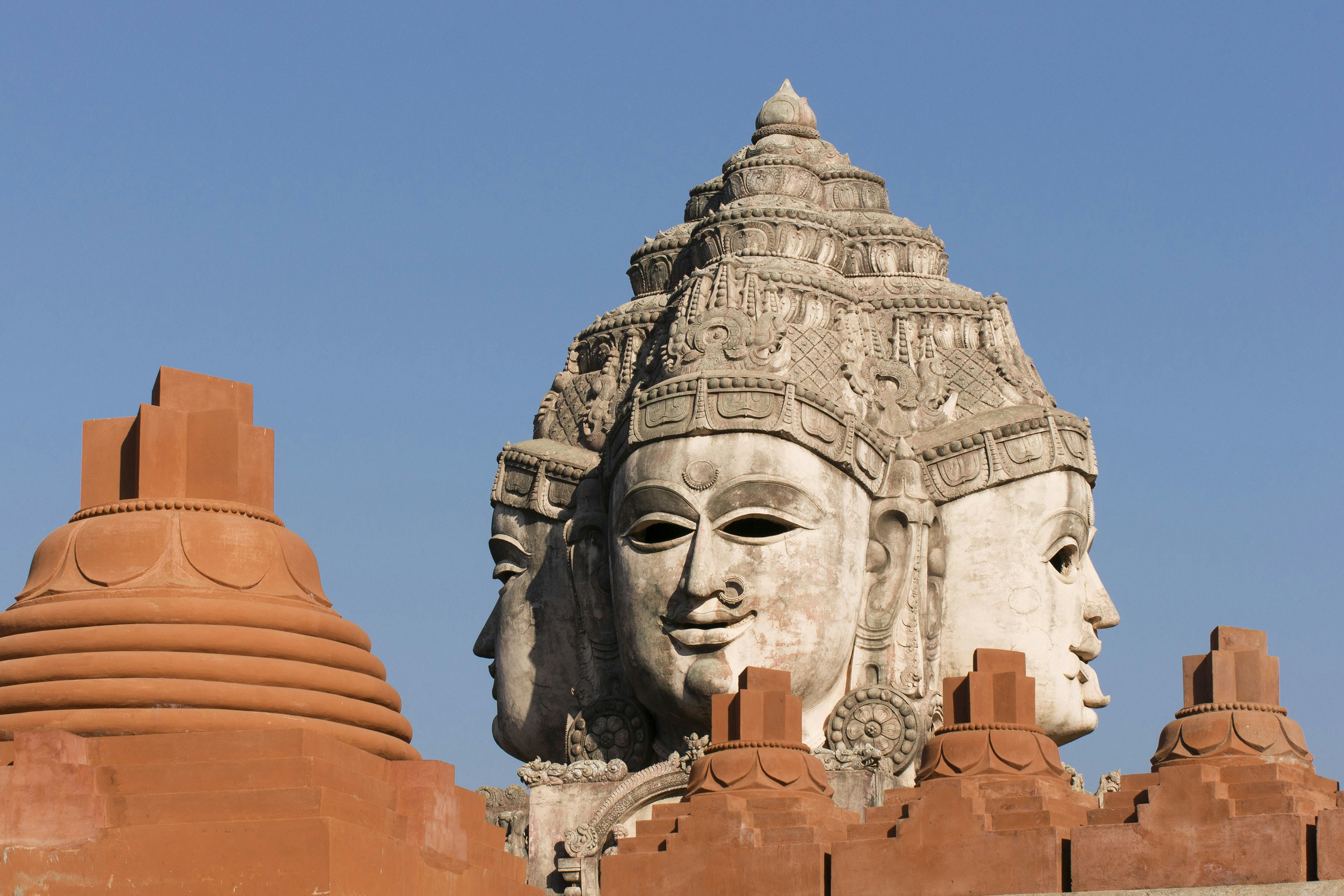 Twin-Headed Summit: Stone Faces Above a Sea of Cenotaphs