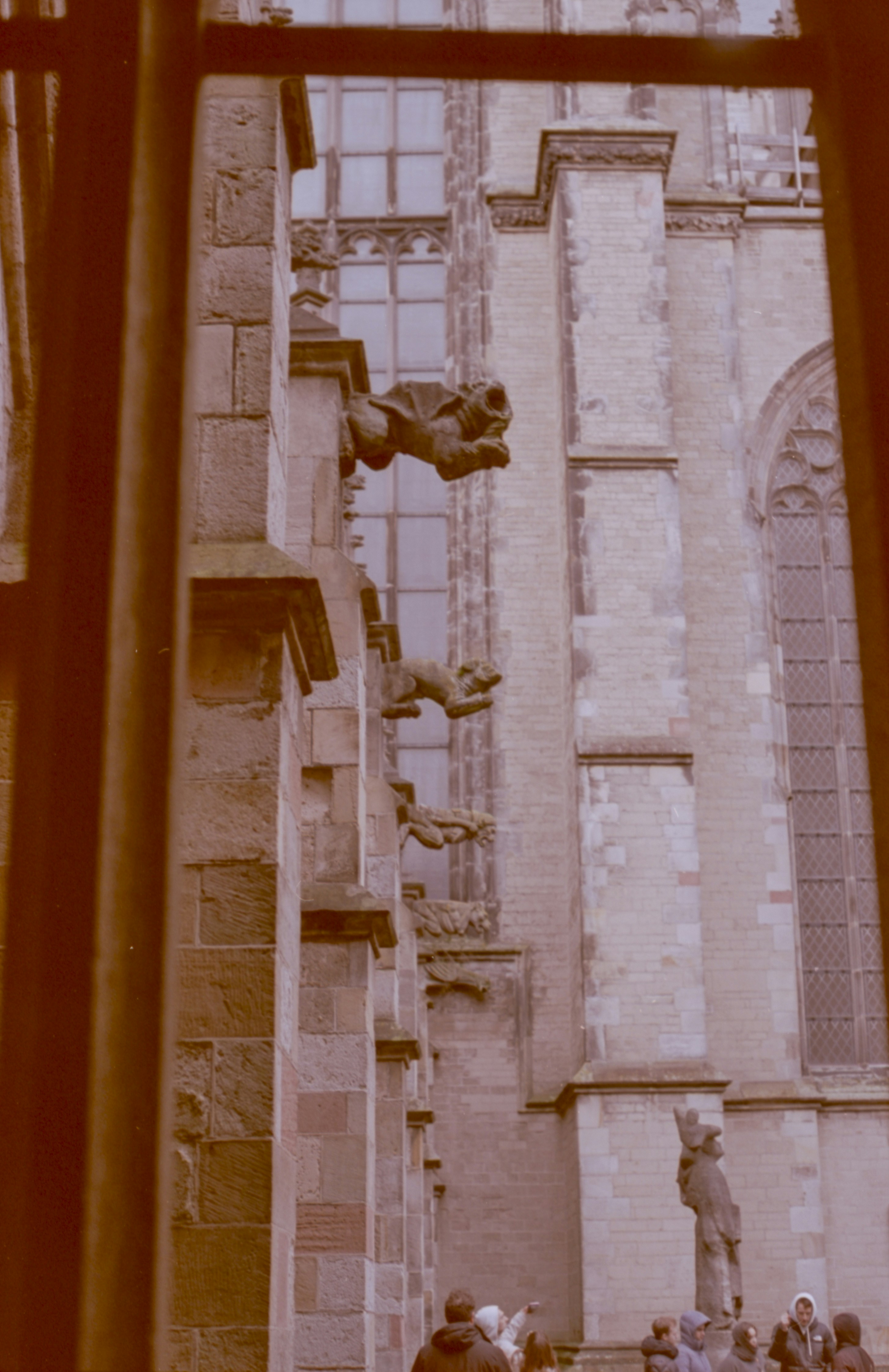 Gargoyles Guard the Gothic Facade Under a Crimson Tint