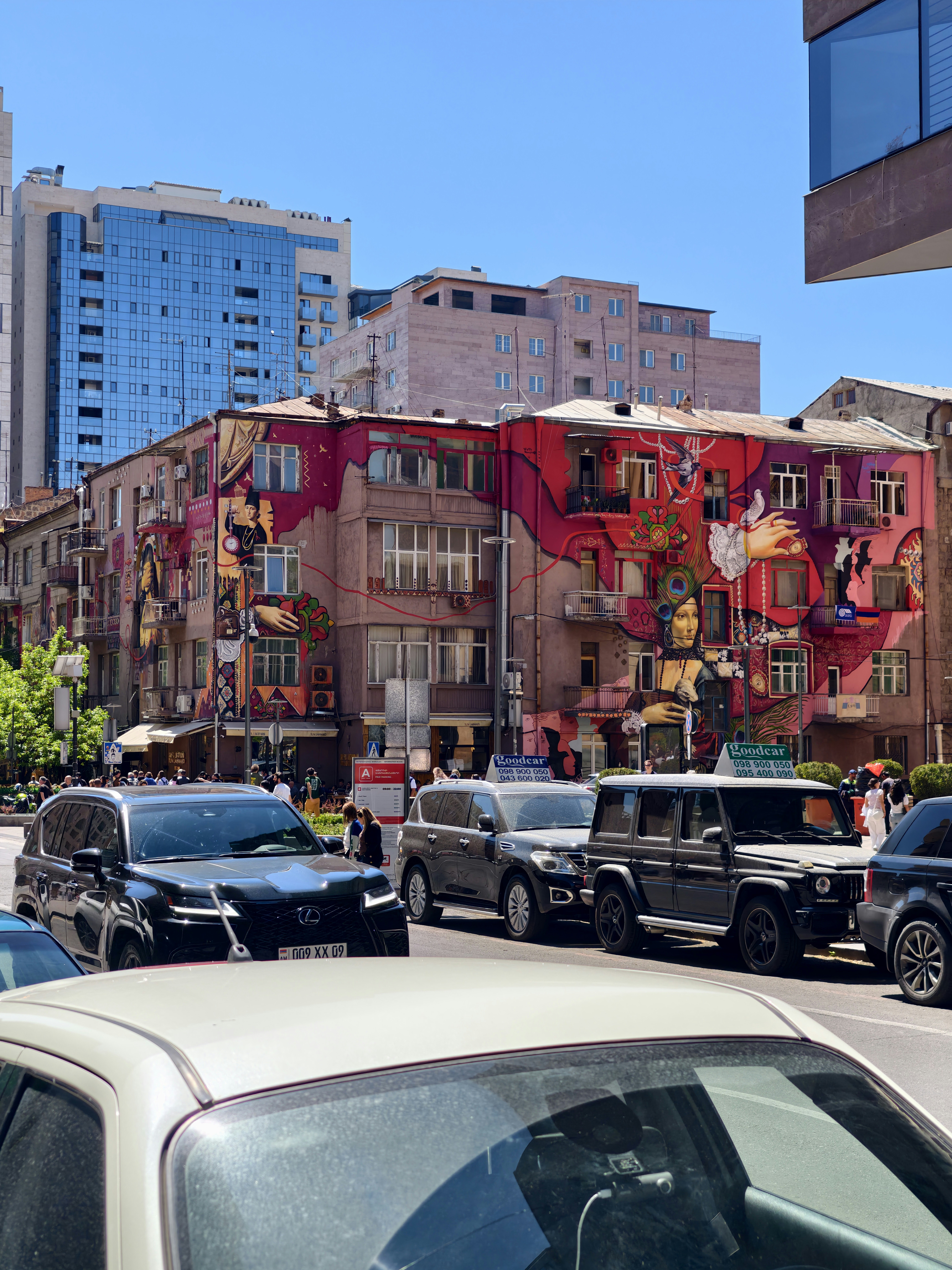 Urban mural of life: a busy street scene framed by colorful graffiti apartment walls