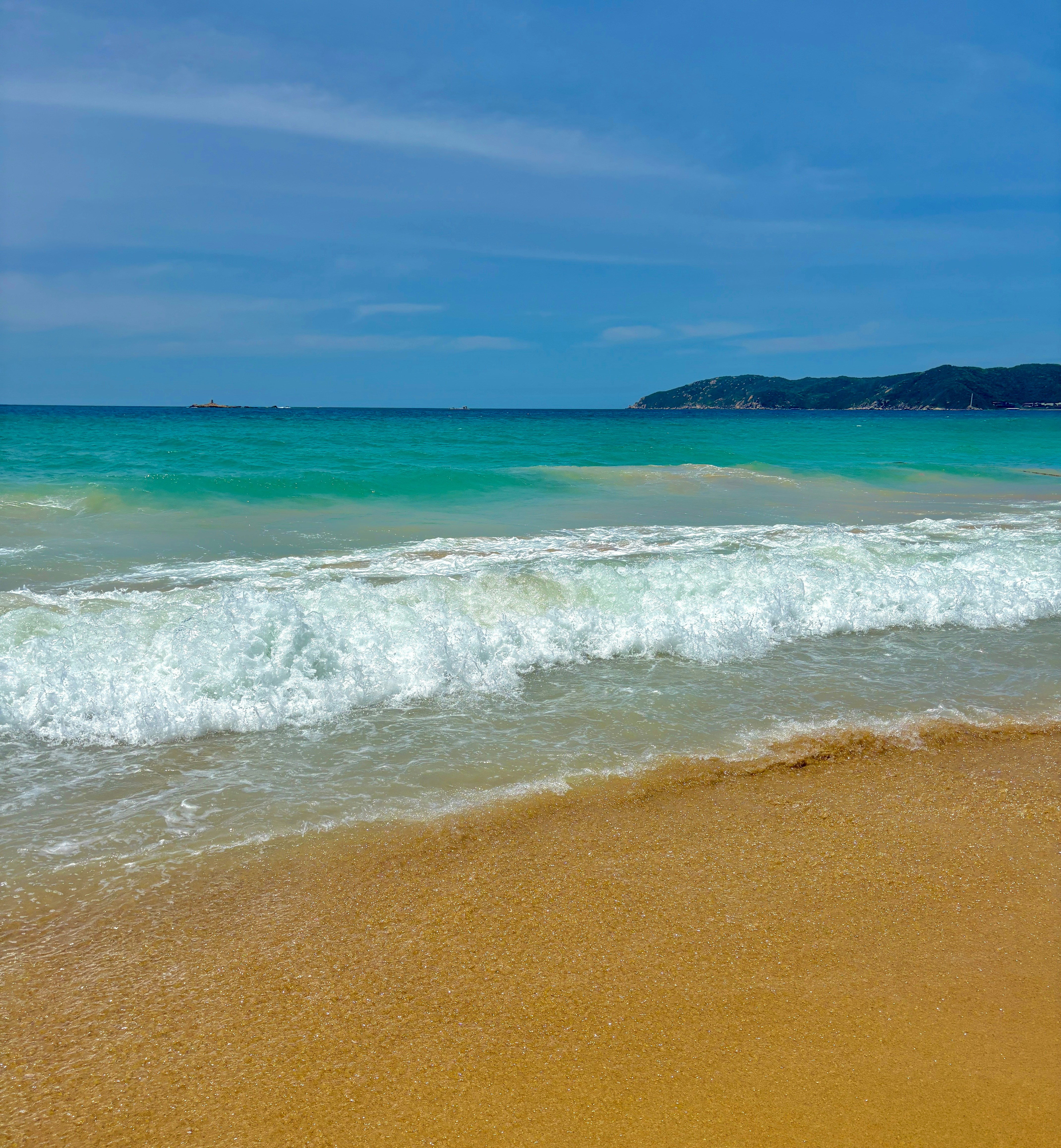 Golden Shoreline under a Clear Arc of Sky