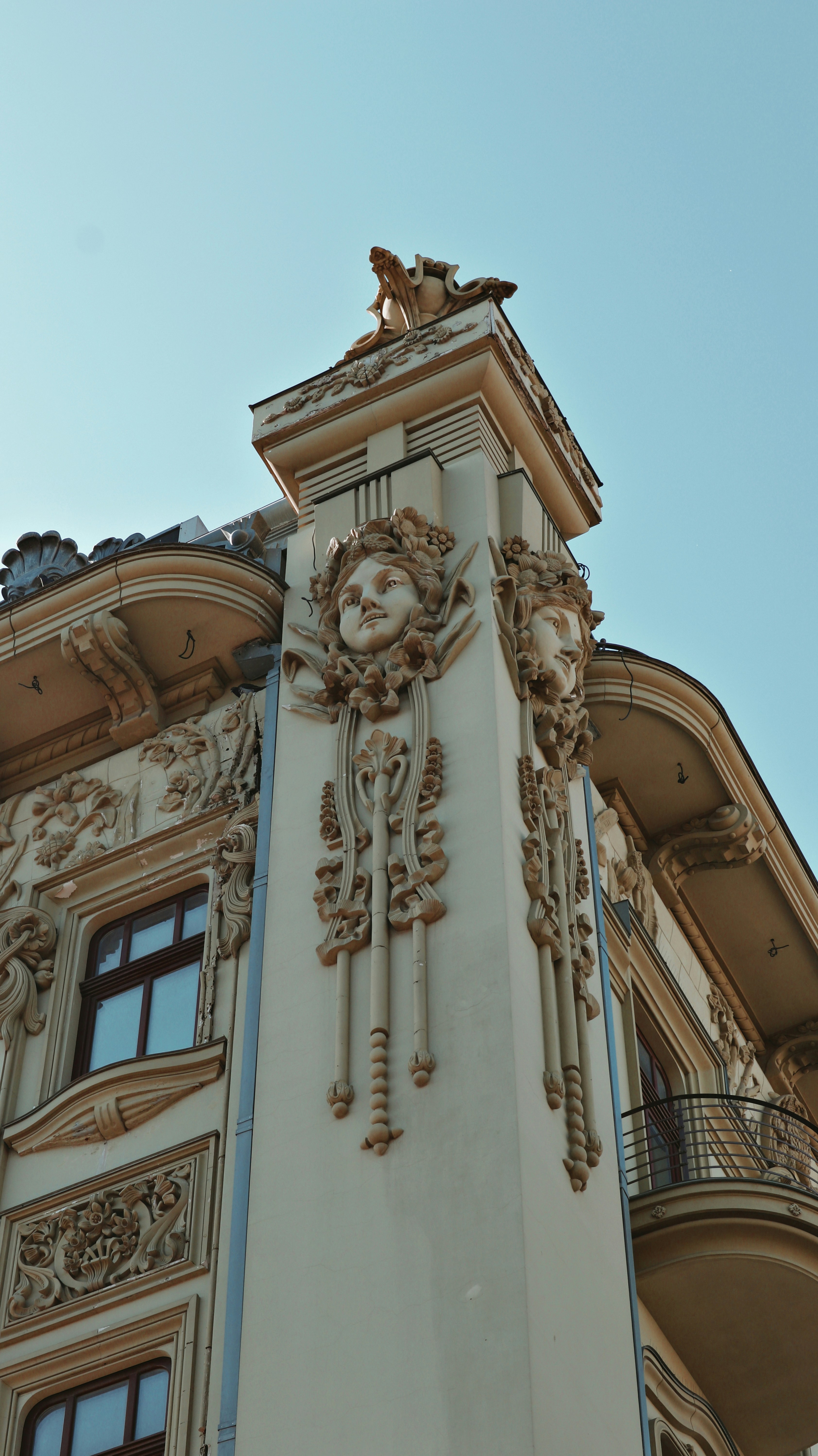 Ornate façade with sculpted angelic figures rising toward the sky
