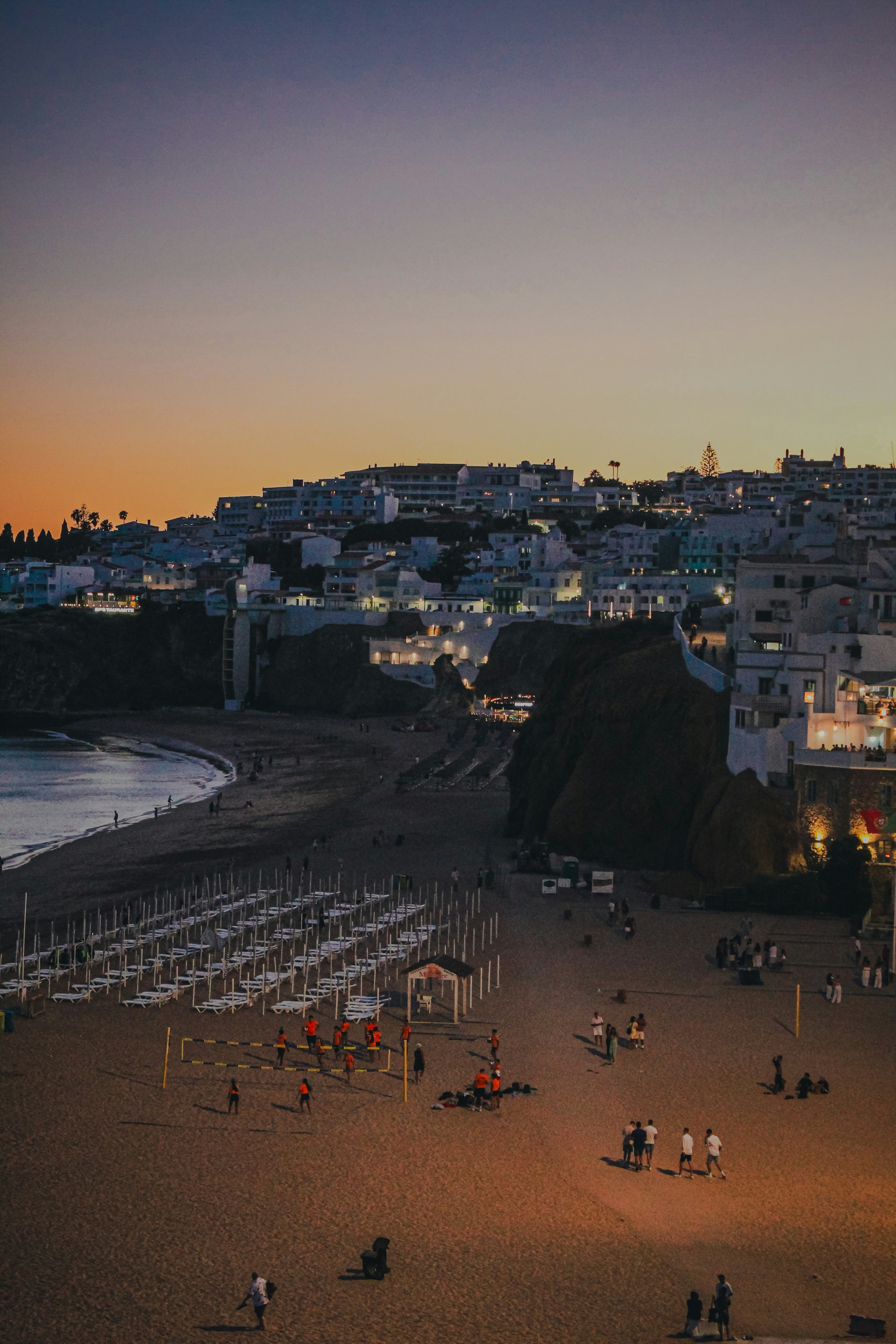 Sunset Terrace Overlook: A coastal town tucked beneath cliffside lights