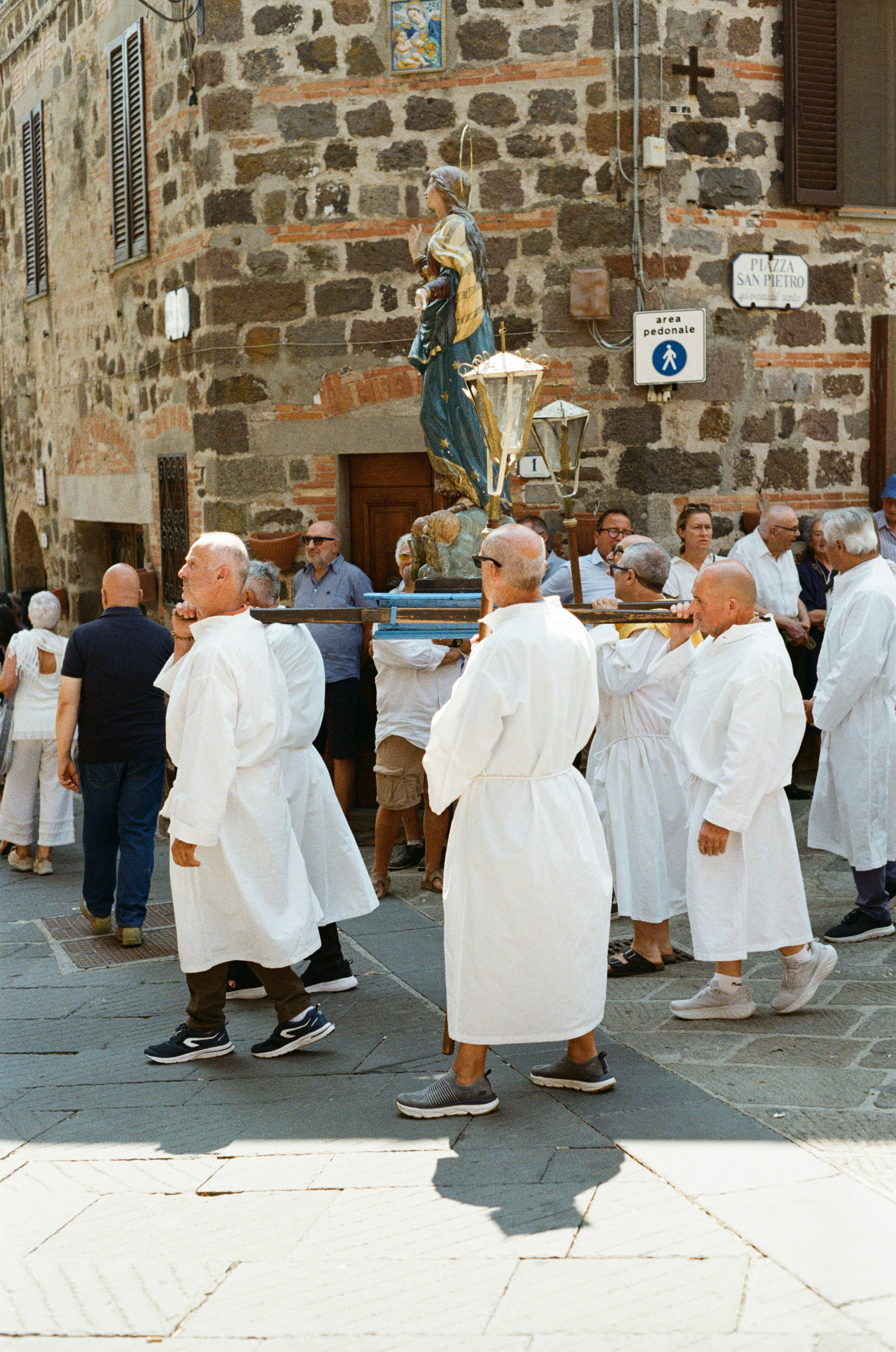 Procession of White-Robed Acolytes Carrying a Statuesque Reliquary Through a Stone-Cut Piazza