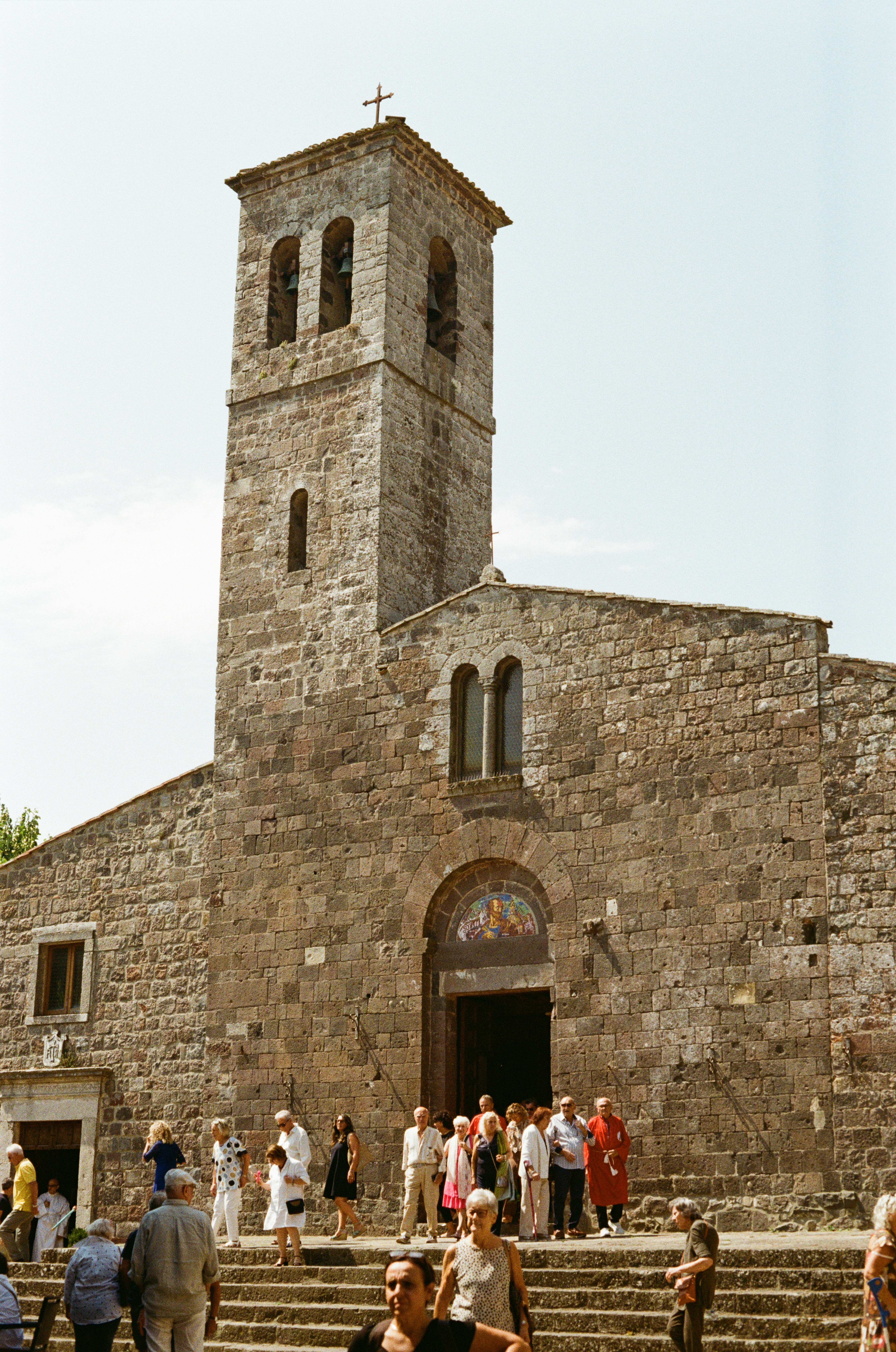 Stone Church at the Foot of the Bell Tower, Sunlit Steps and Gathering