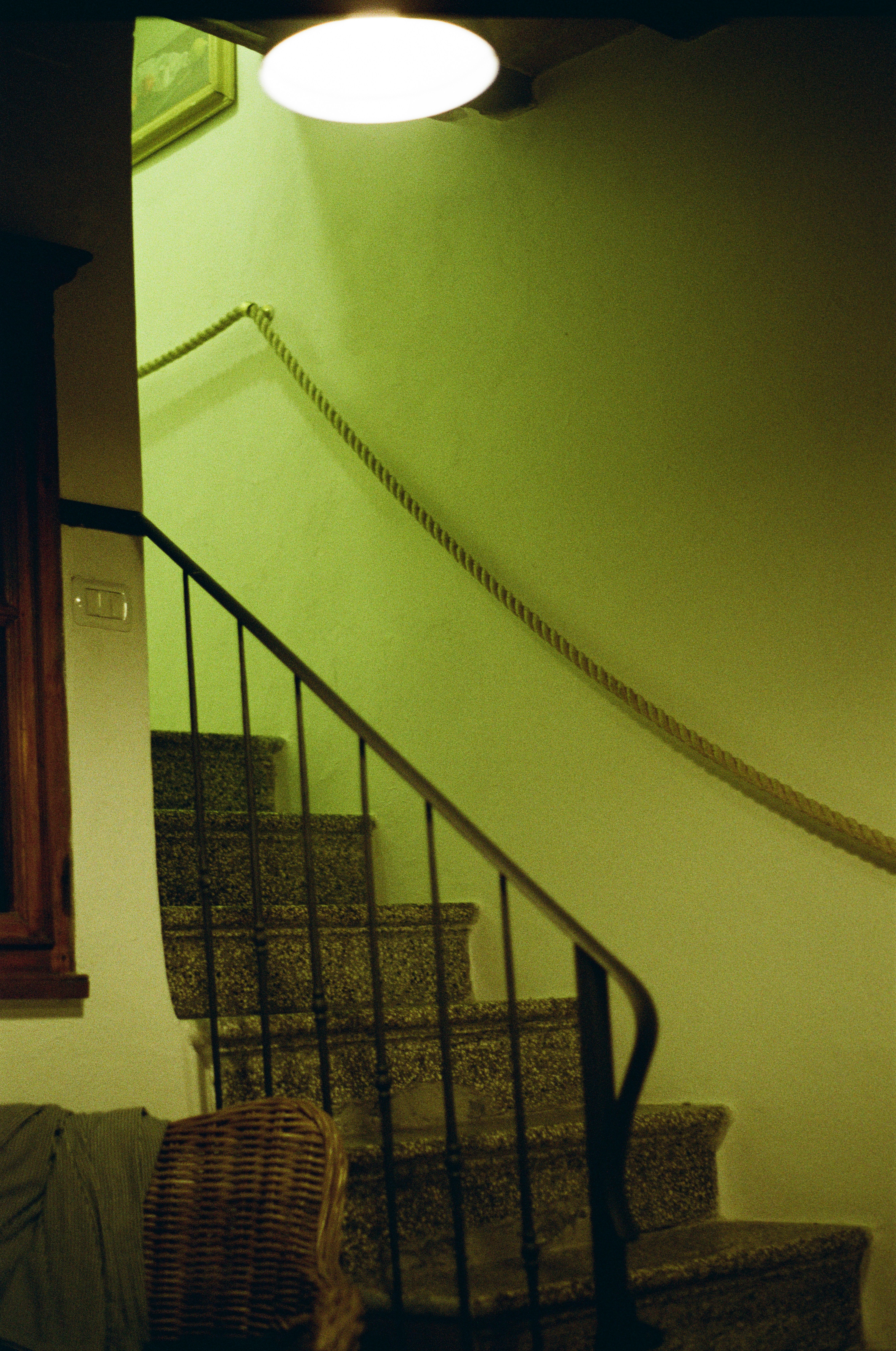 Staircase in a Quiet Corner: Light, Railing and Basket