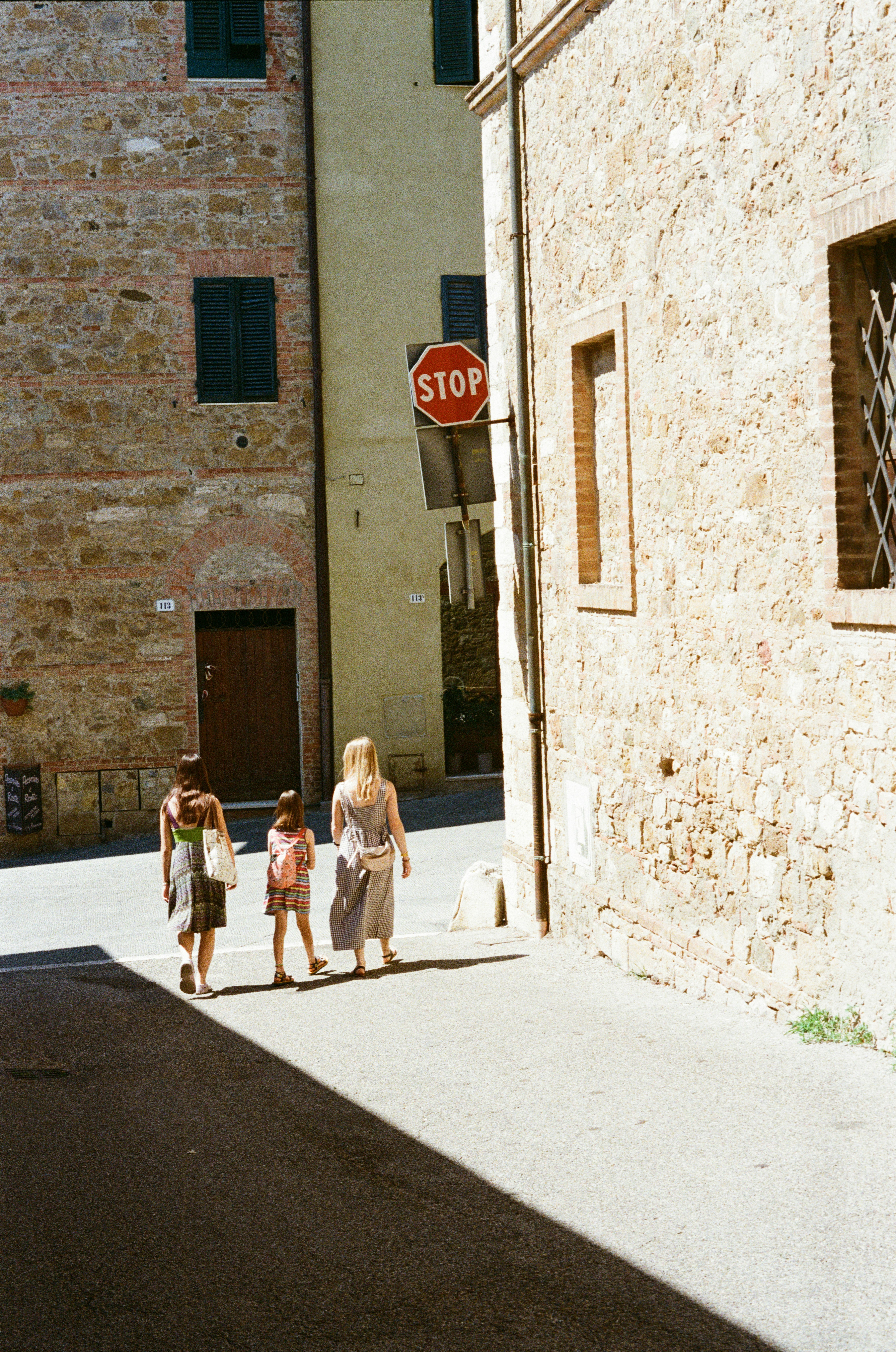Three Walkers into the Sunlit Alley