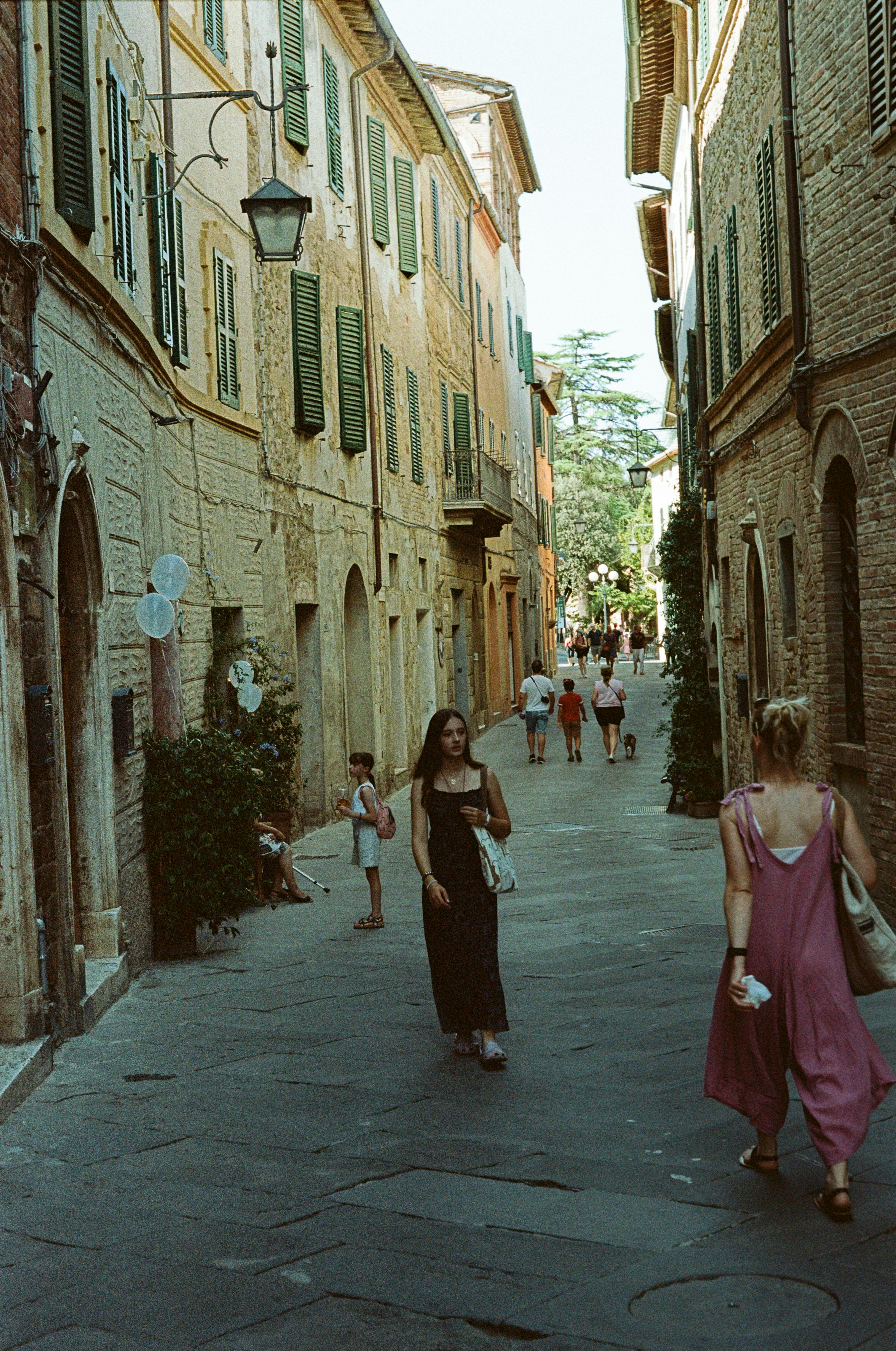 Quiet Street Blues: Women Walk the Sunlit Italian Alley