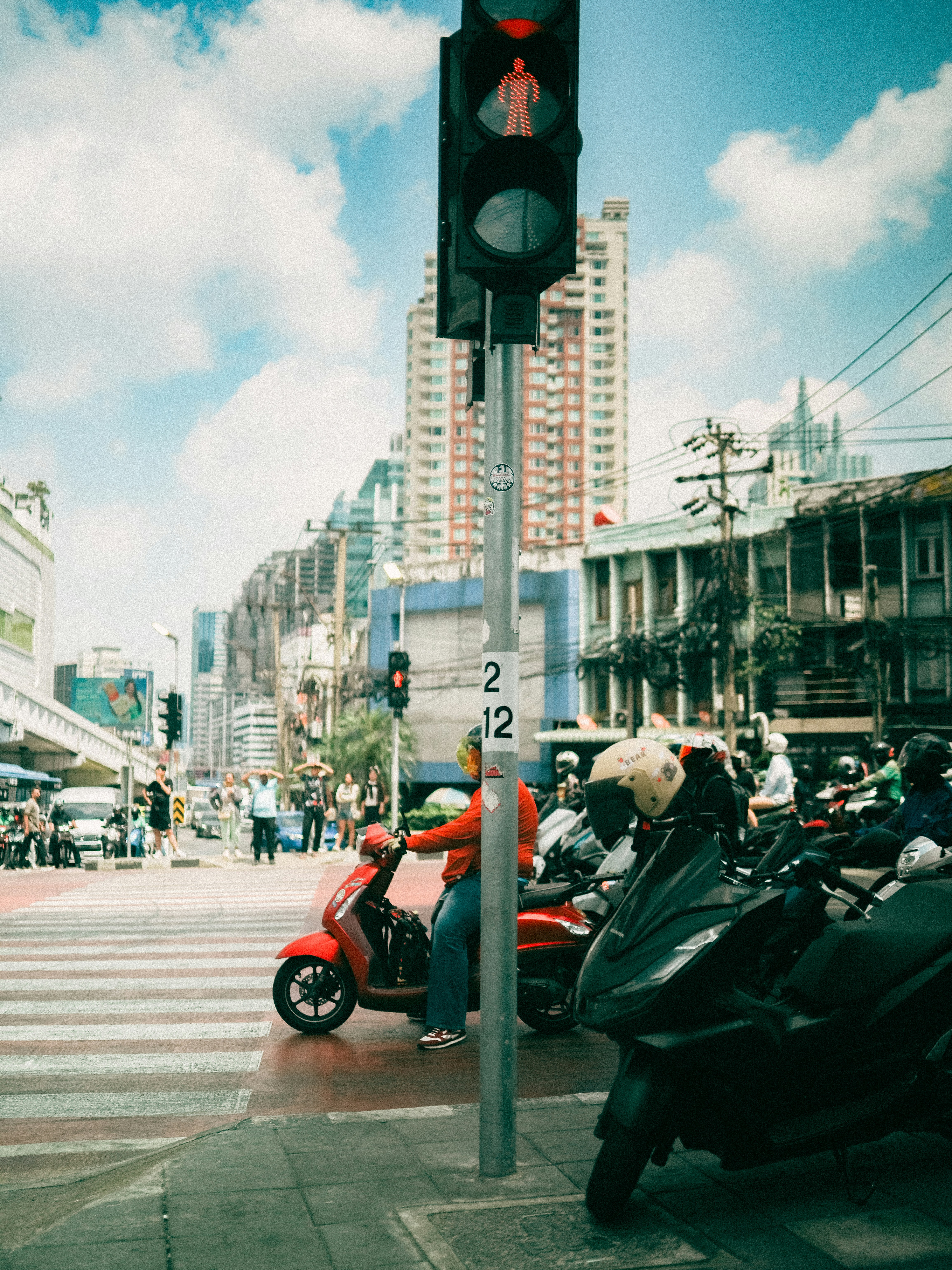 Red Scooter Pause at a City Crosswalk