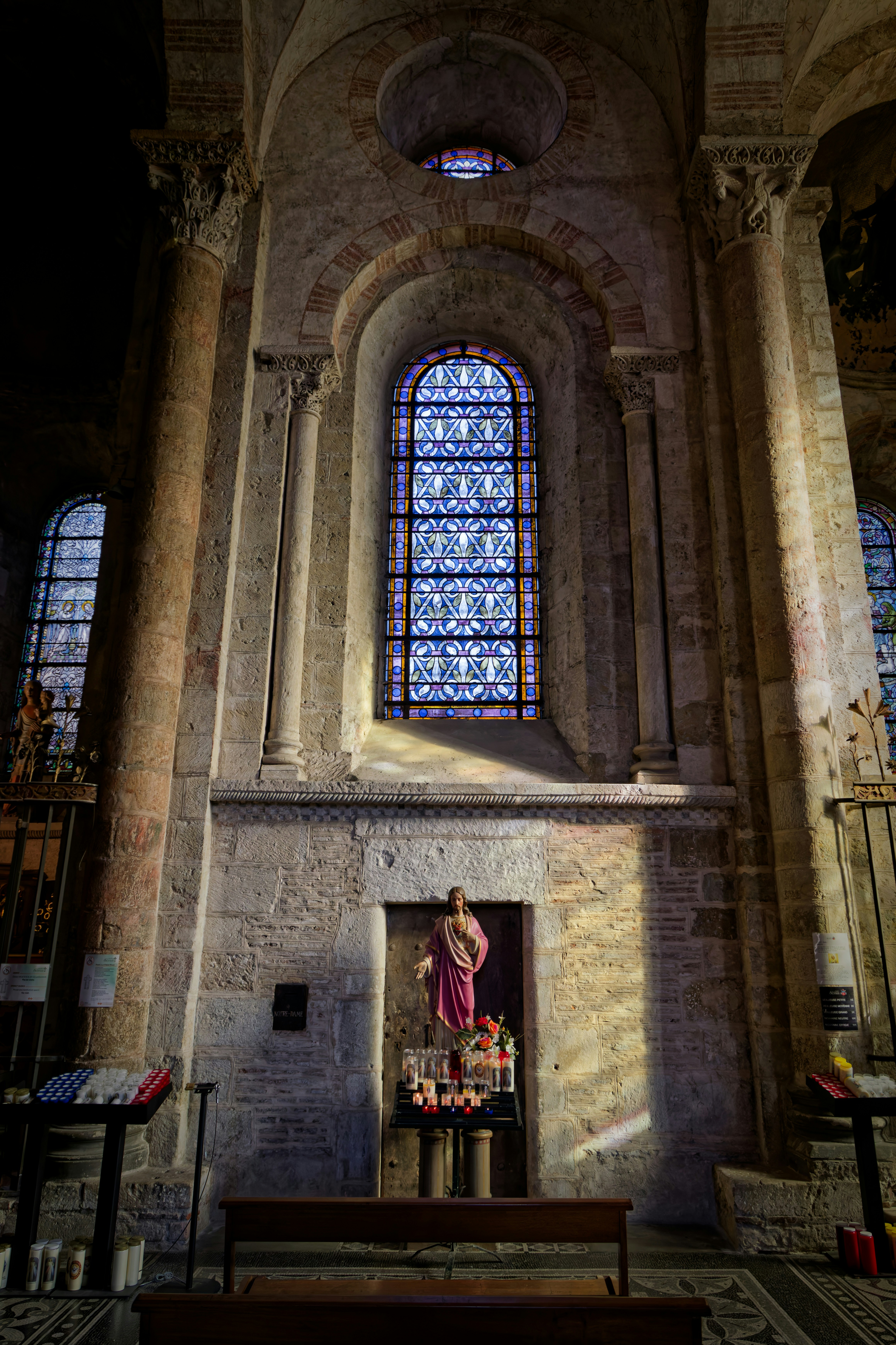 Stained Glass Quietness: Light, Statue, and Stone