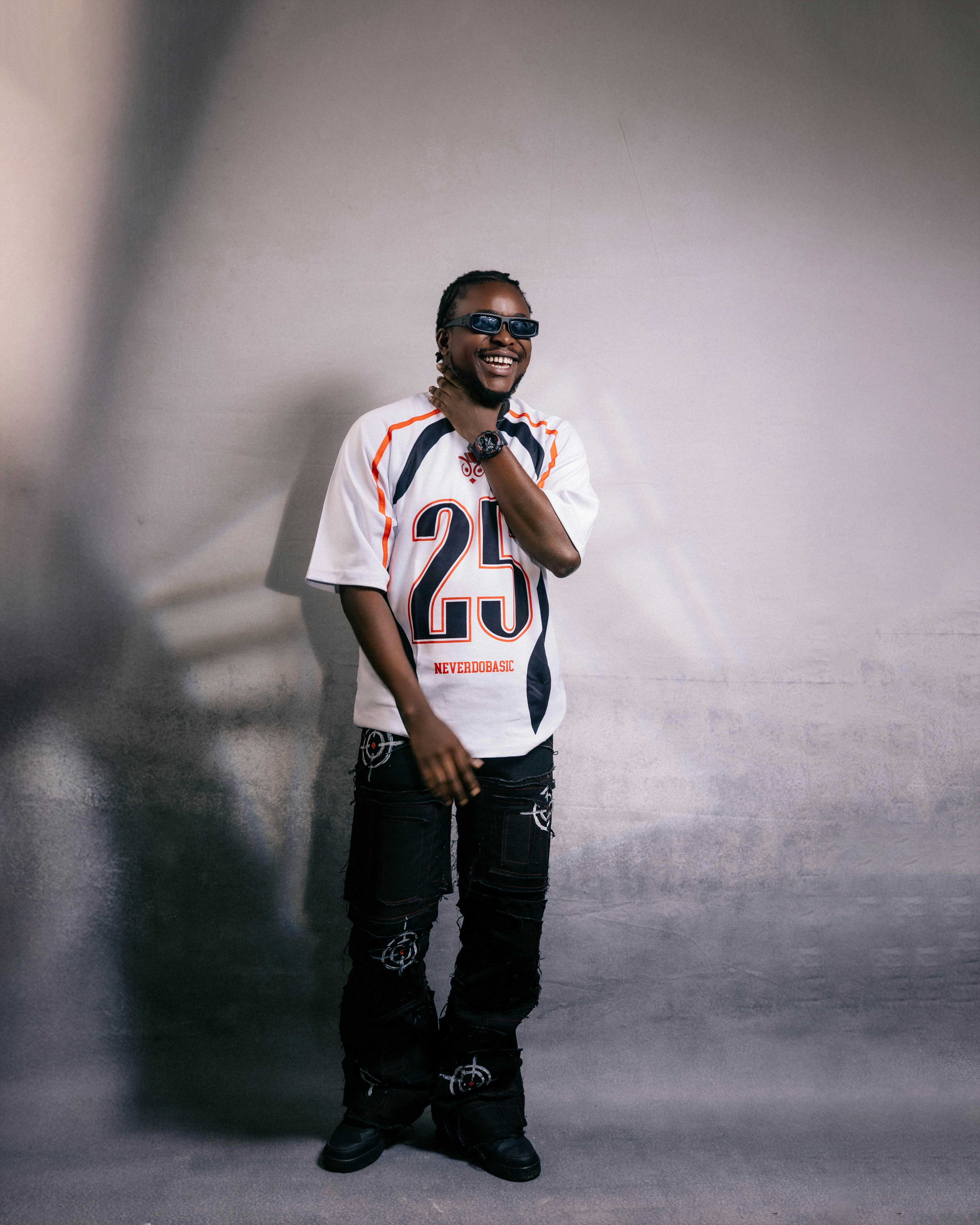 Smiling Stance in a Shadowed Studio