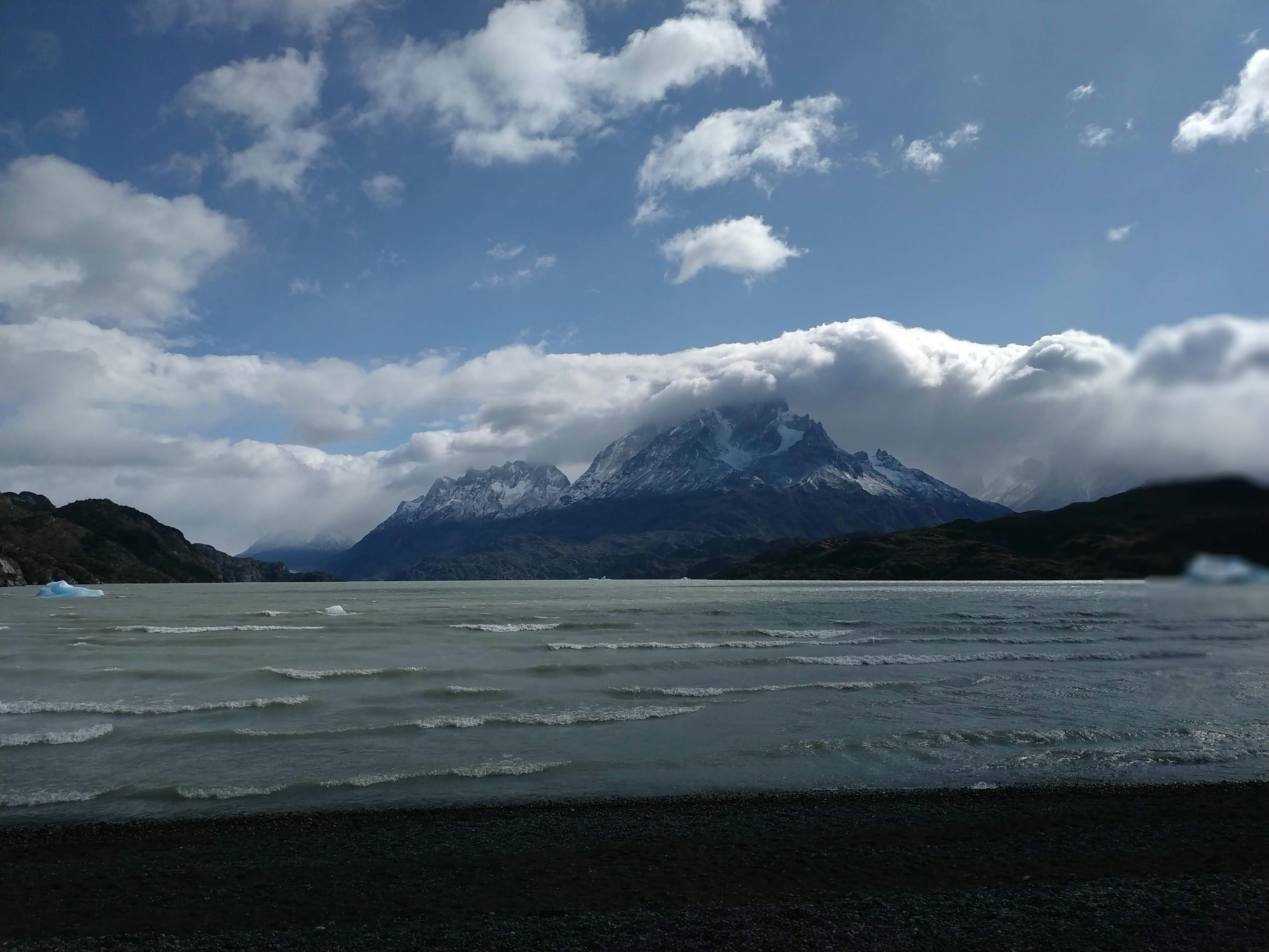 Snow‑capped Peak Rising Behind A Misty Fjord