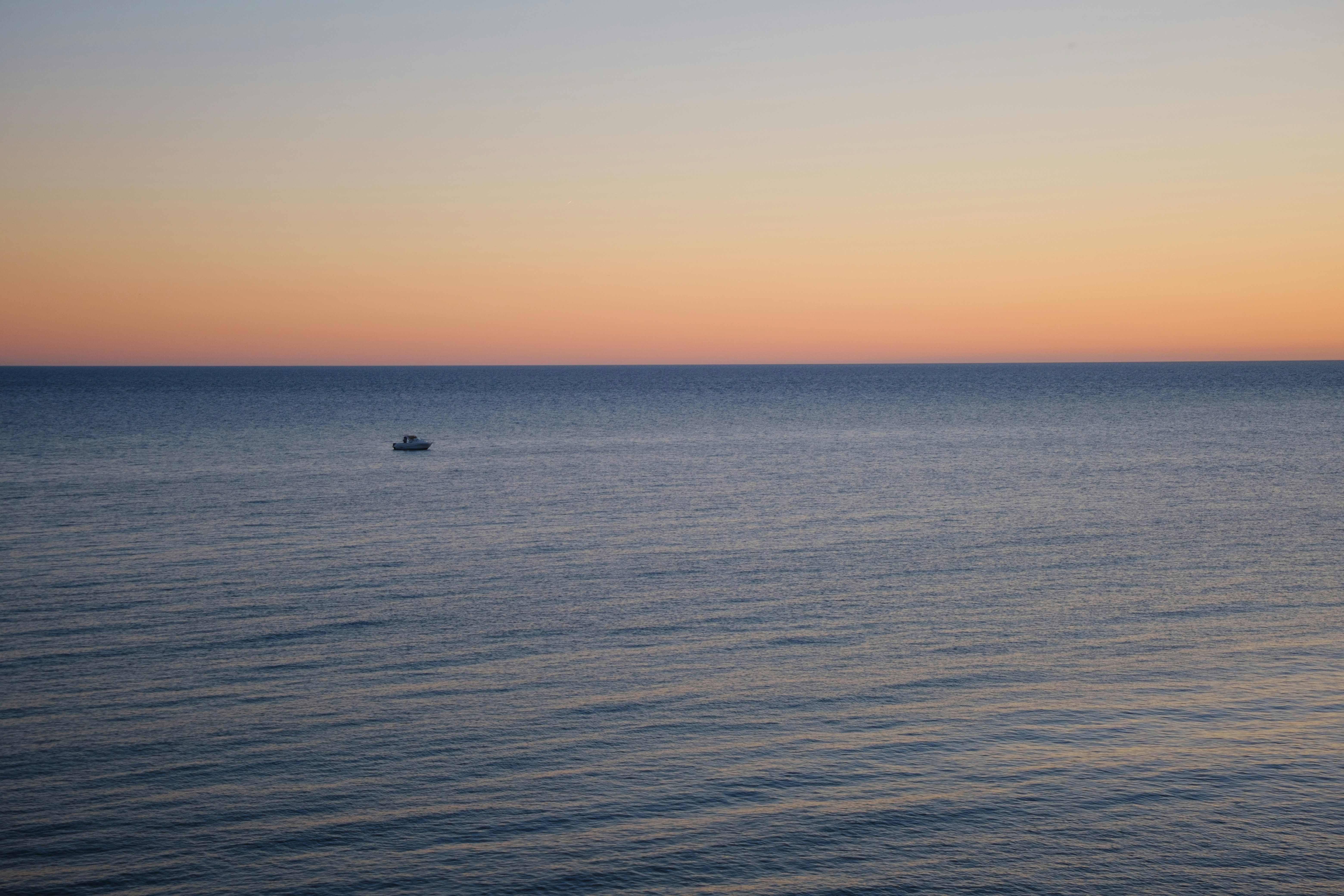 Drift at Dusk: A Lone Boat on Velvet Seas