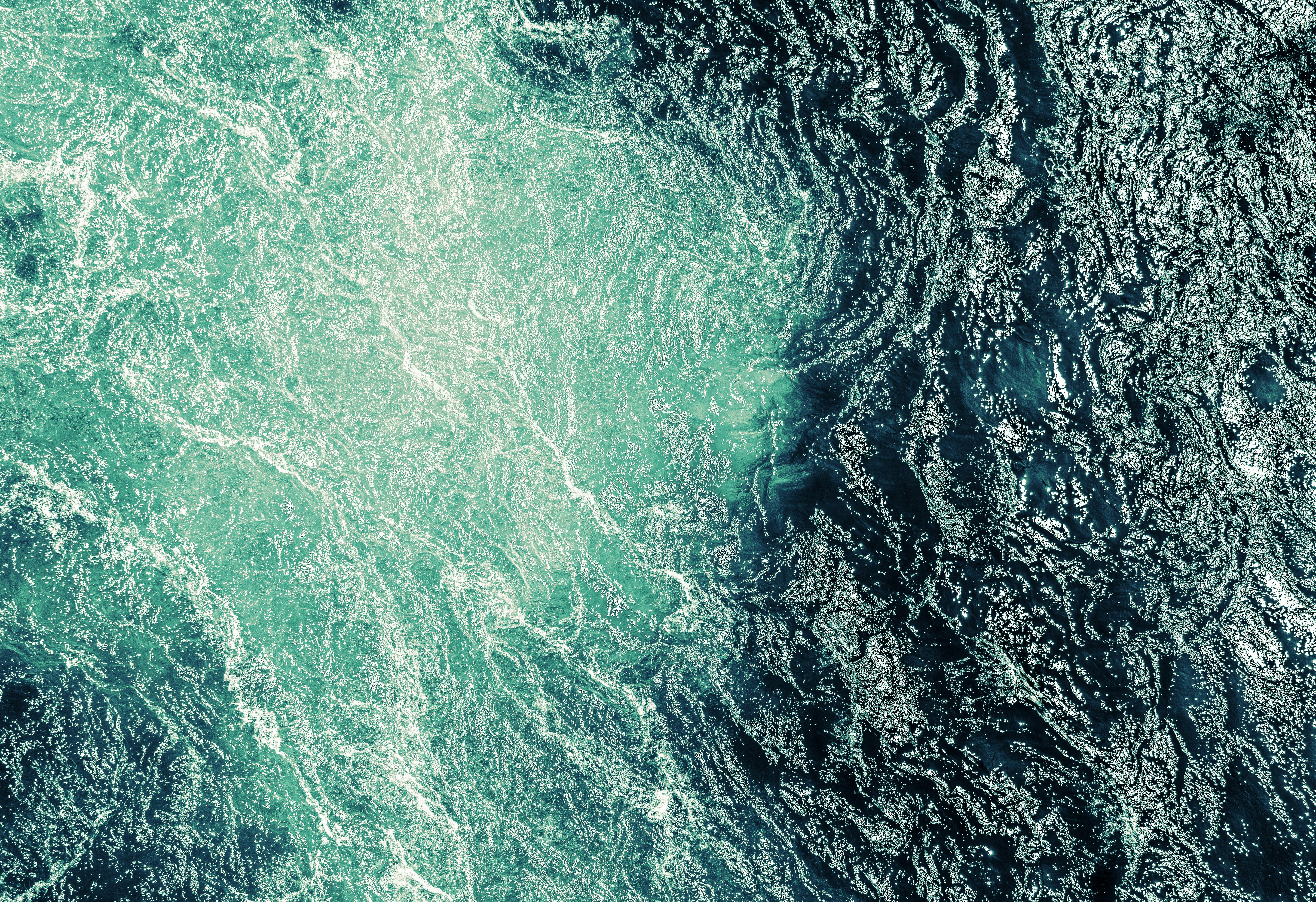 Turquoise Curl: Aerial Pause on Turbid Seas