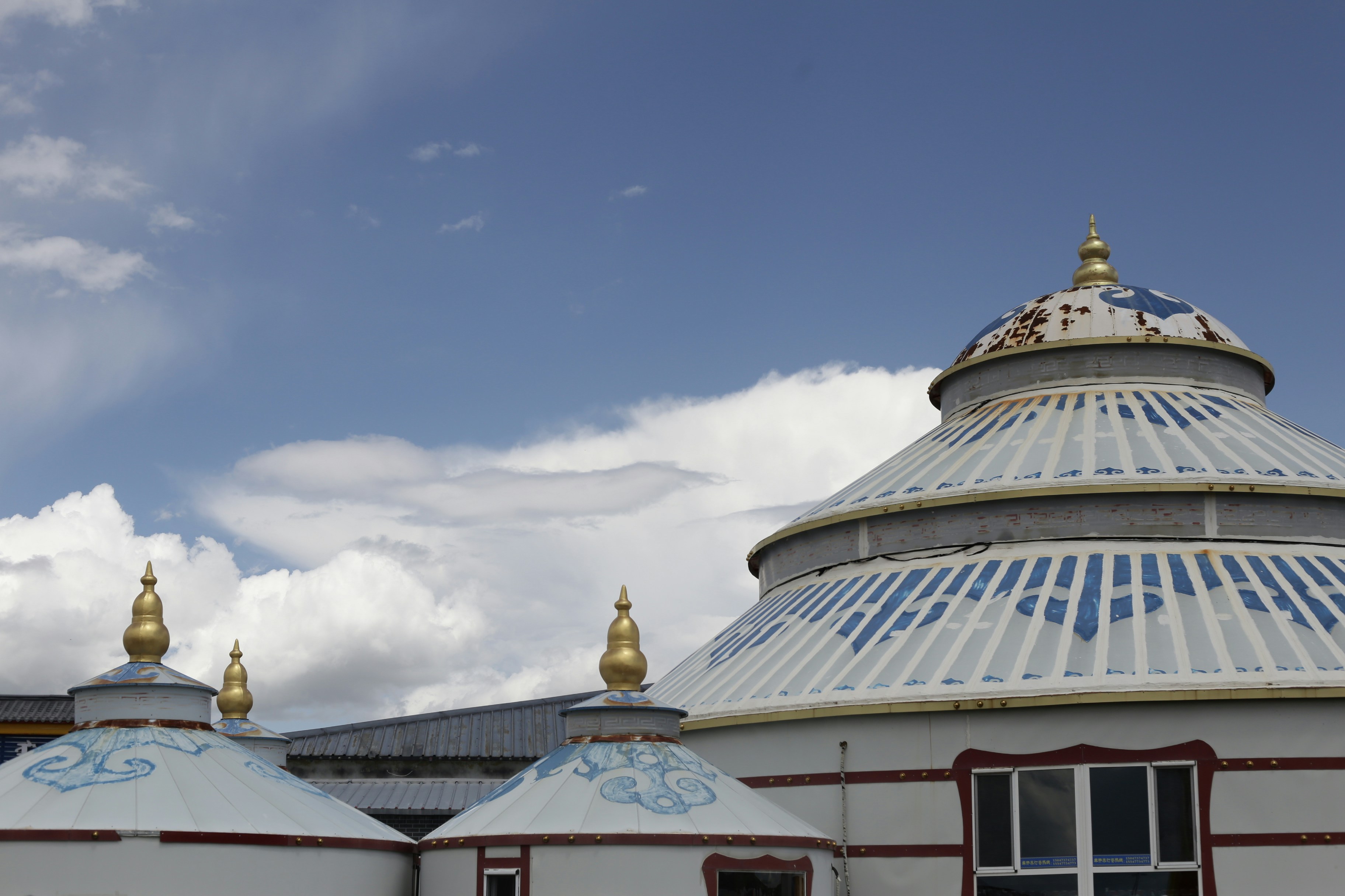 Dome Silhouette: Golden Finials Against a Blue Sky