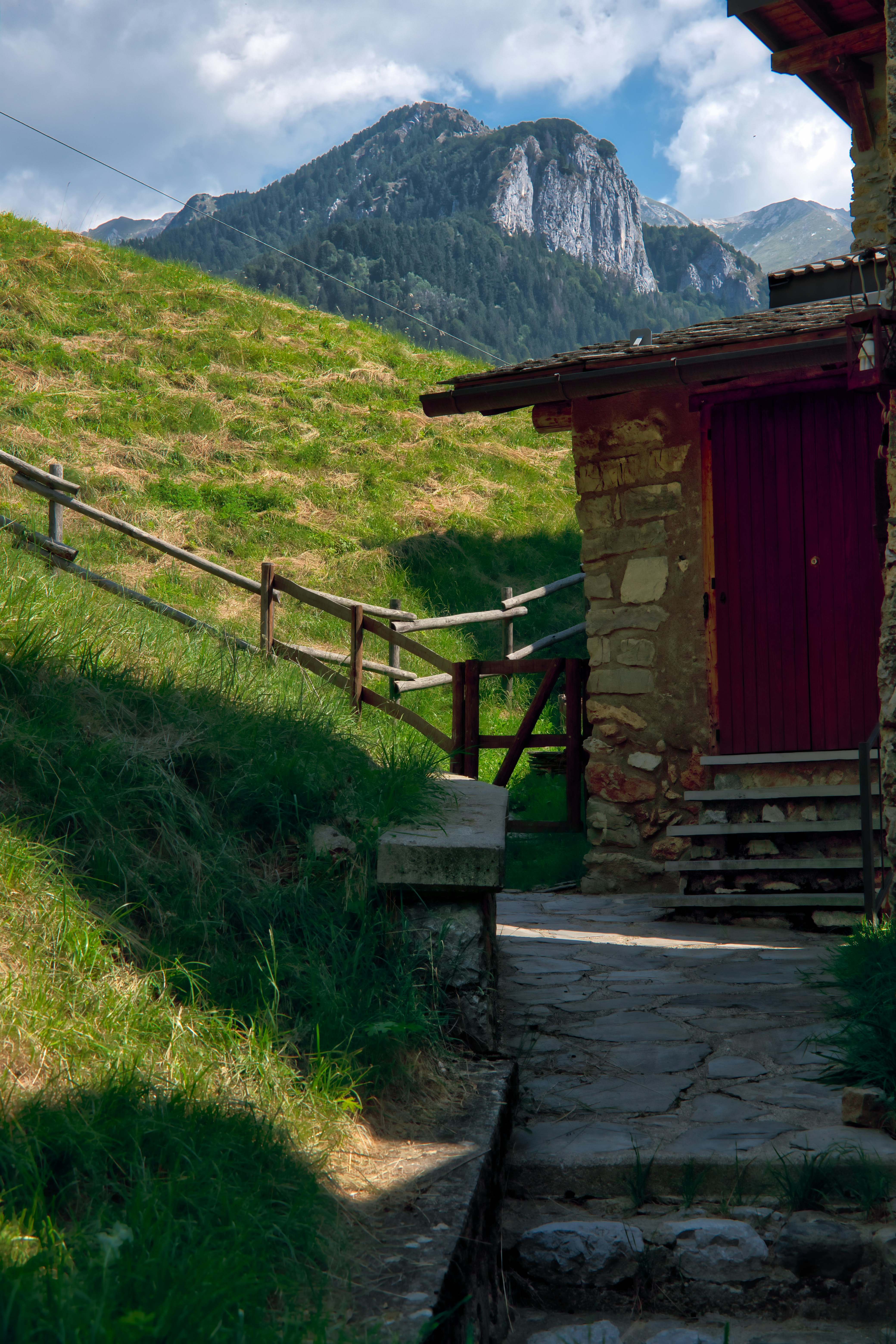 Mountain Chapel Threshold: Sunlit Path to the Rocks