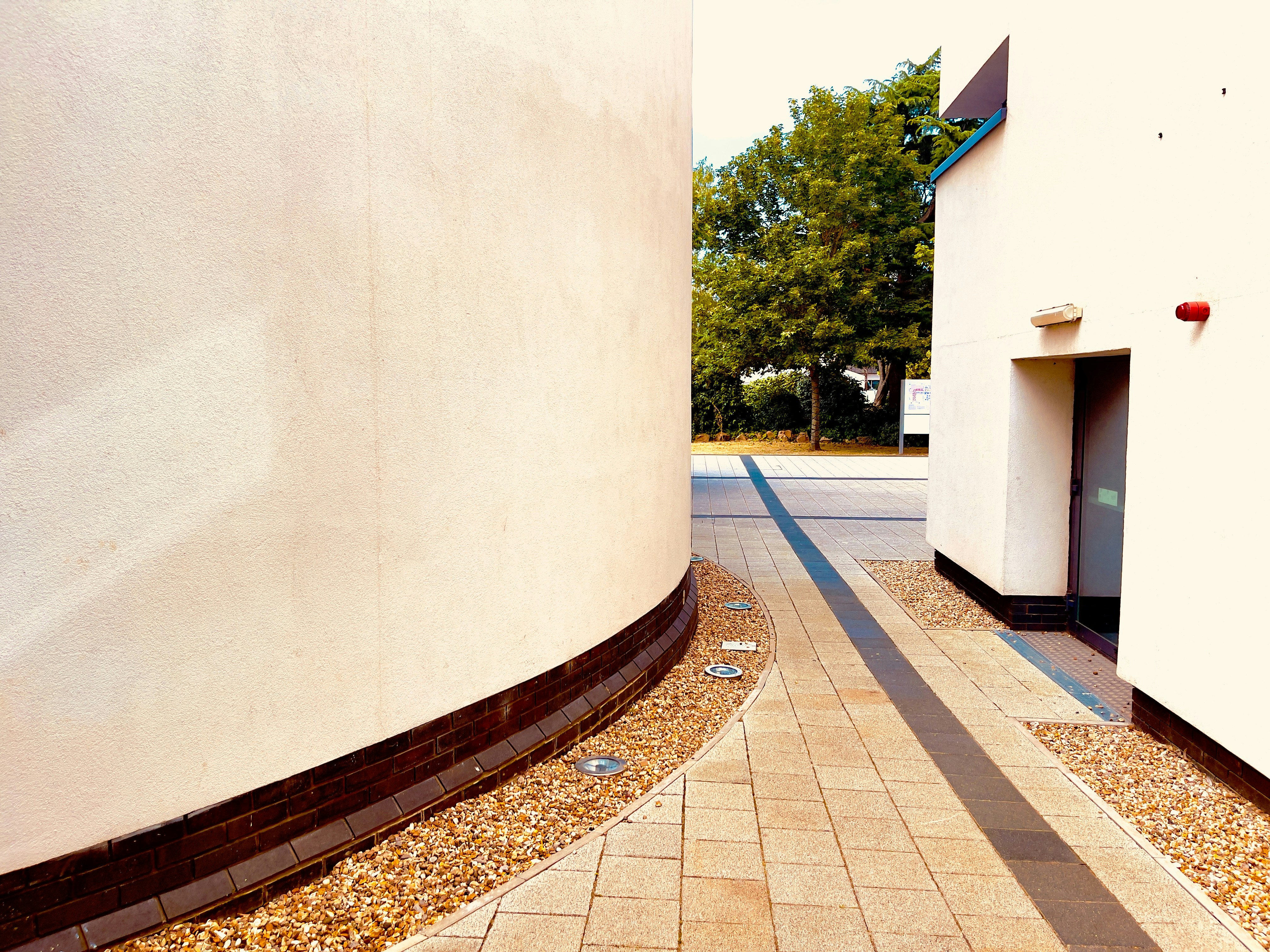 Curved Courtyard Passage Between Modern Walls