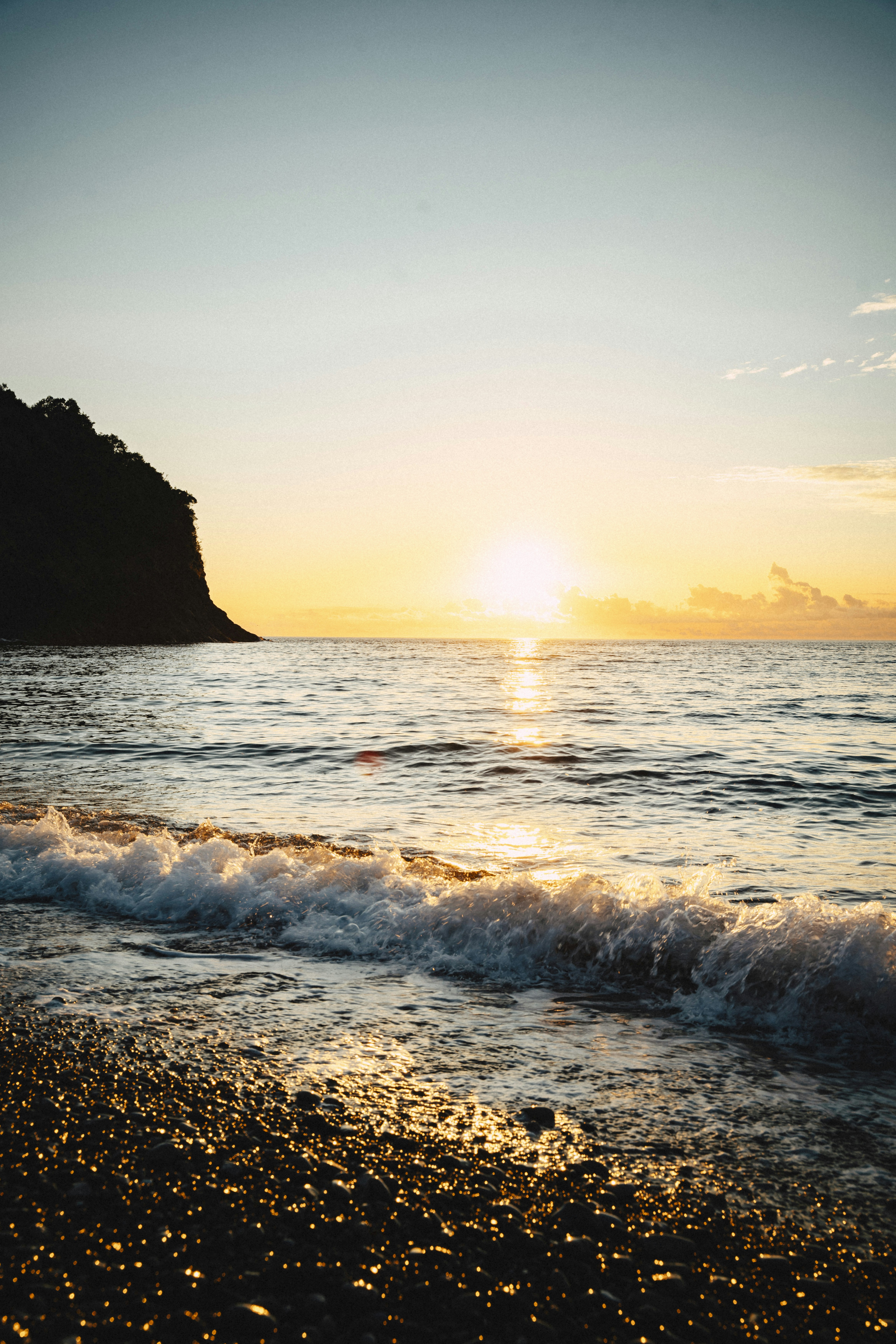 Sunlit Shoreline: Calm Seas Meet the Quiet Cliffs at Dusk