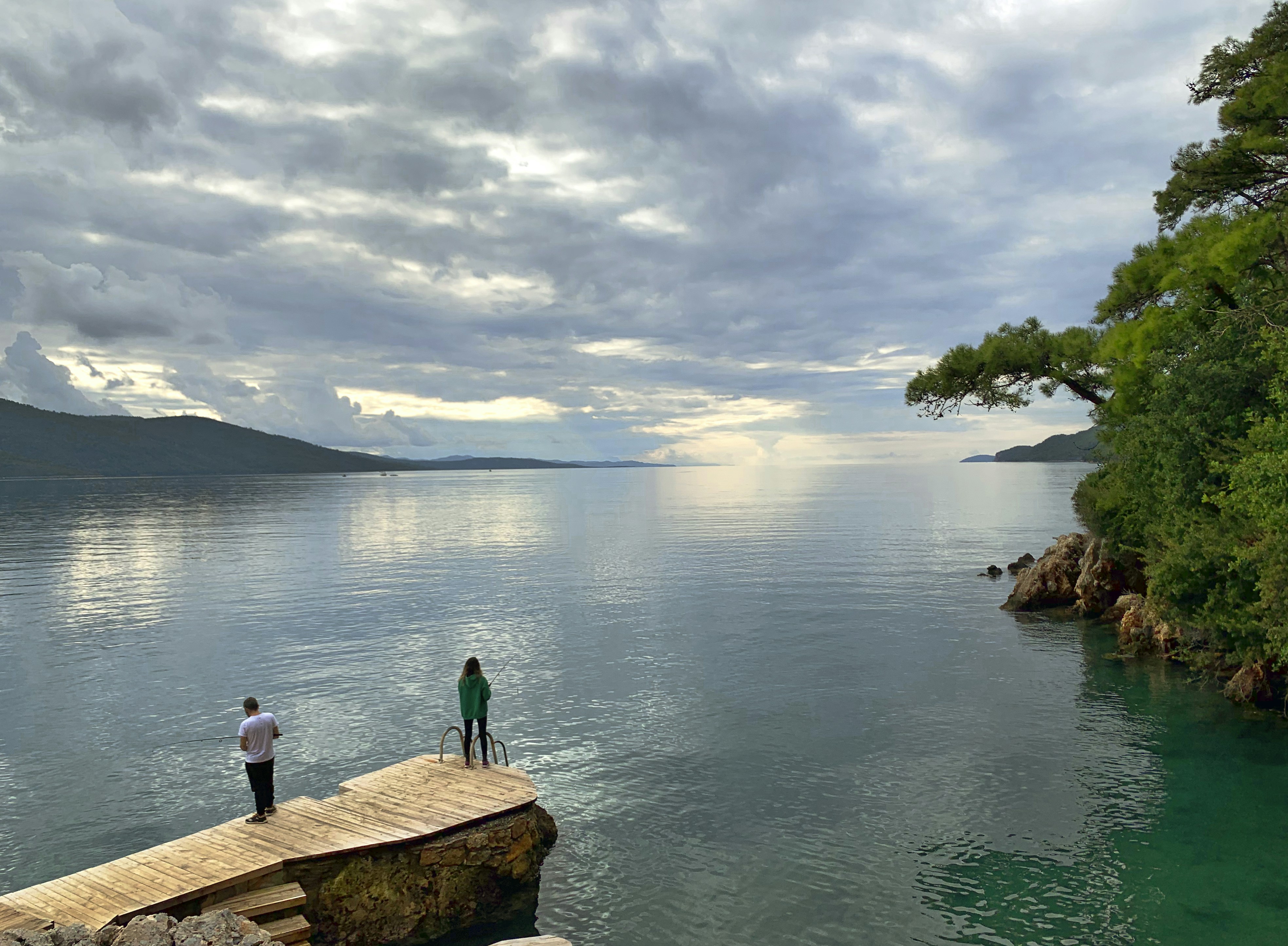 Two Figures at the Edge: Quiet Confluence of Sky and Sea