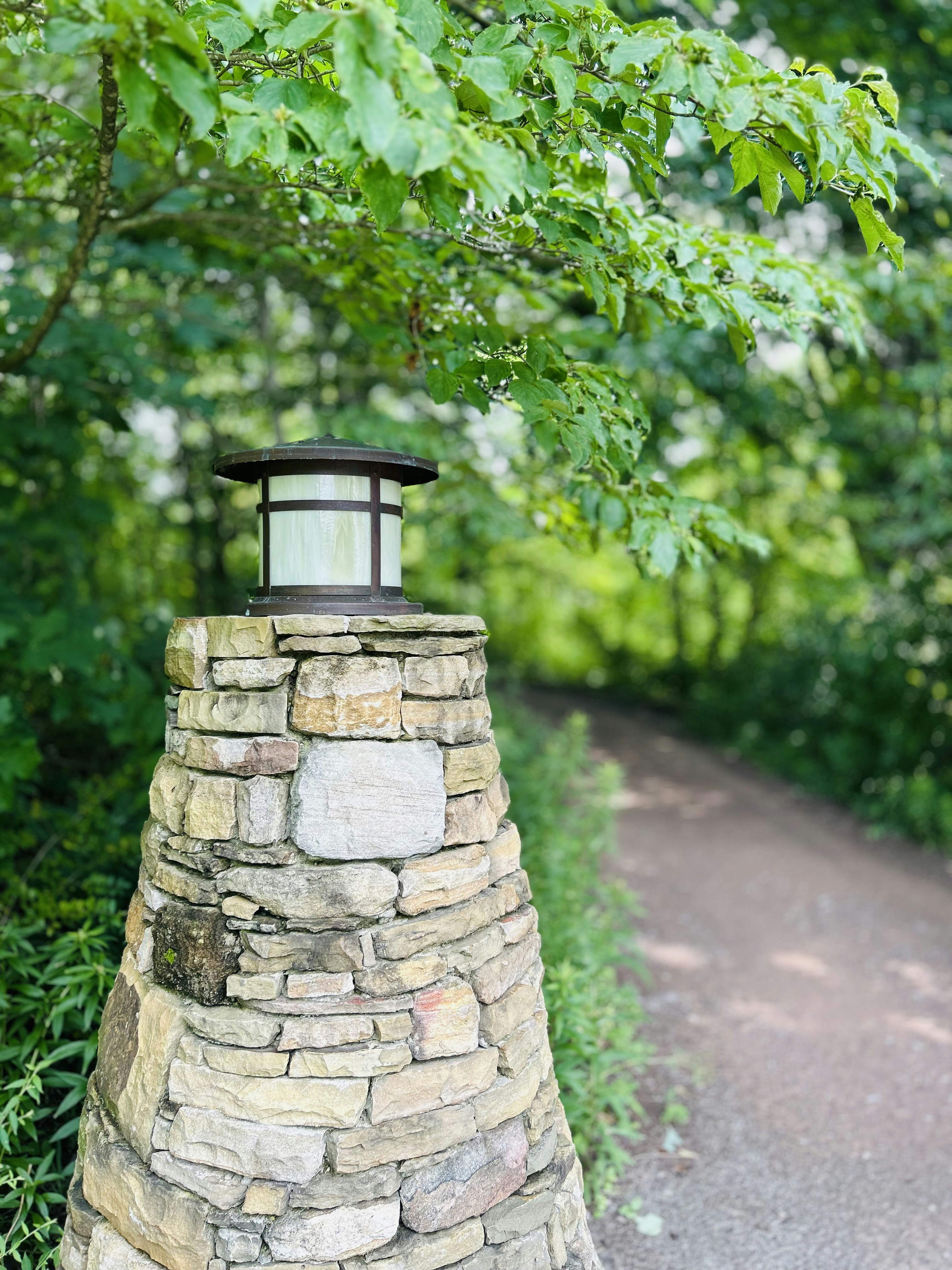 Lantern atop a Stone Pillar Guarding a Verdant Path