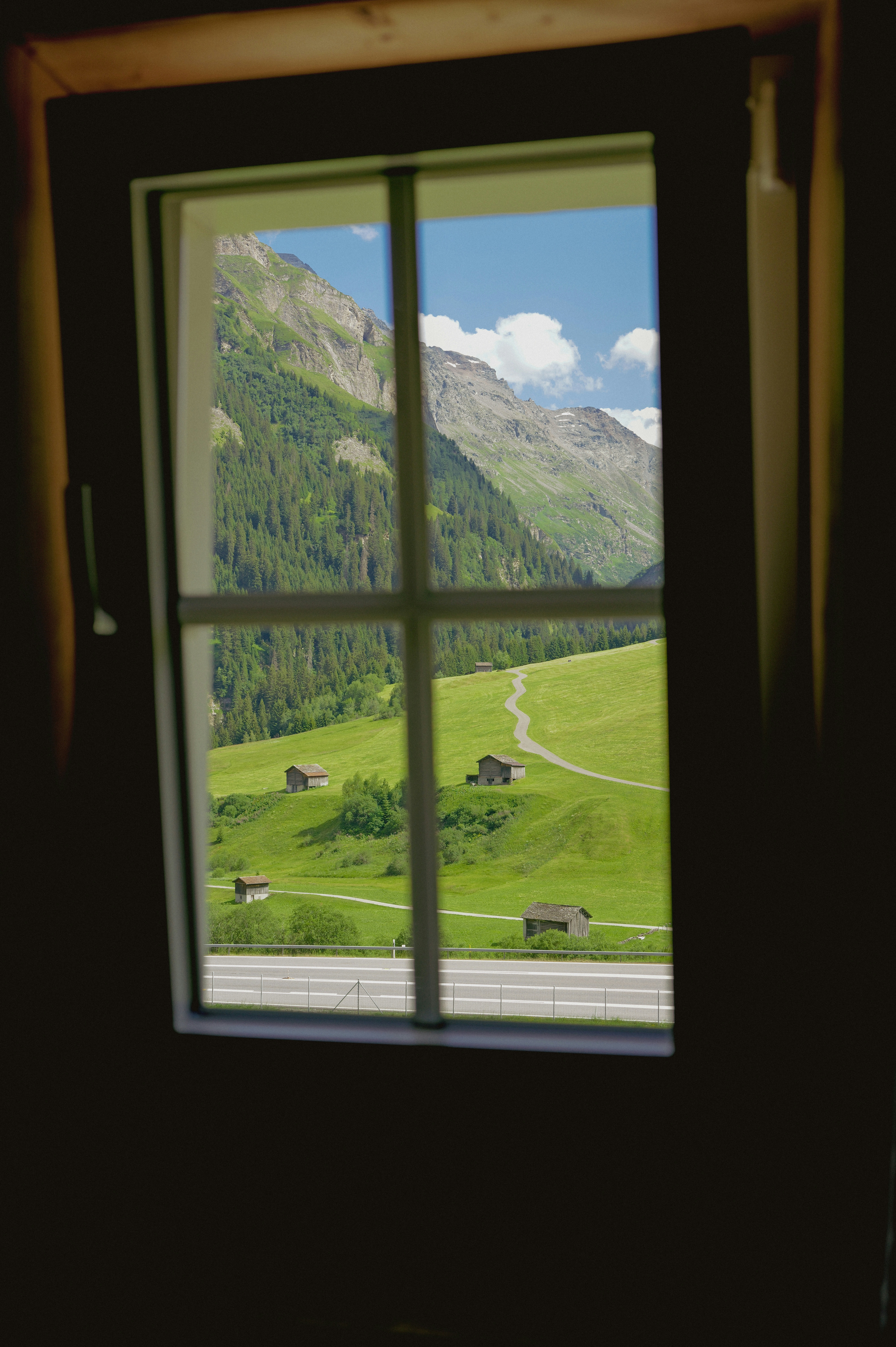 View Through a Frame: Alpine Pastures Meet a Window’s Shadow