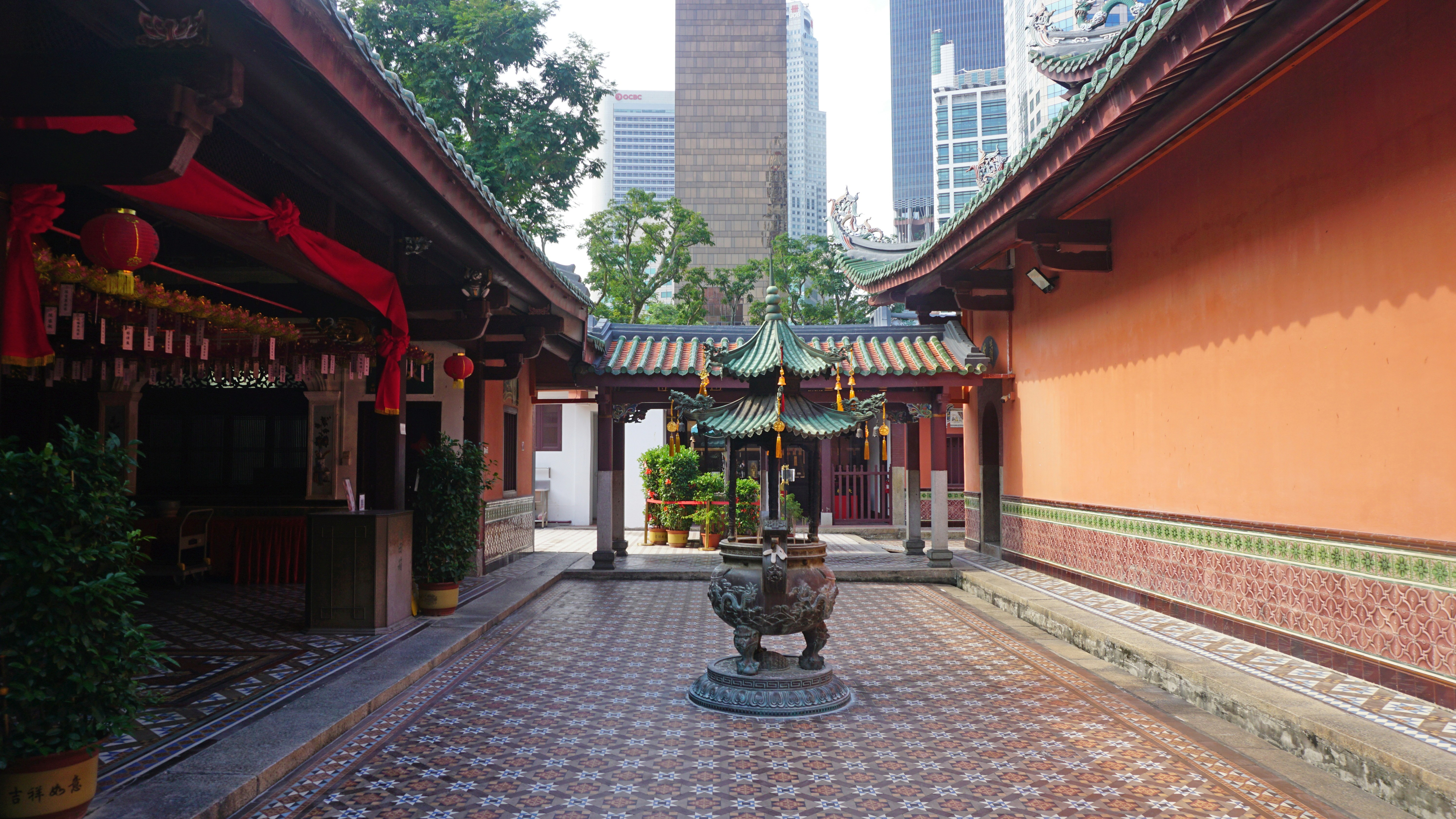 Courtyard Temple Alight: Centerstone of Tradition Amid Skyscrapers