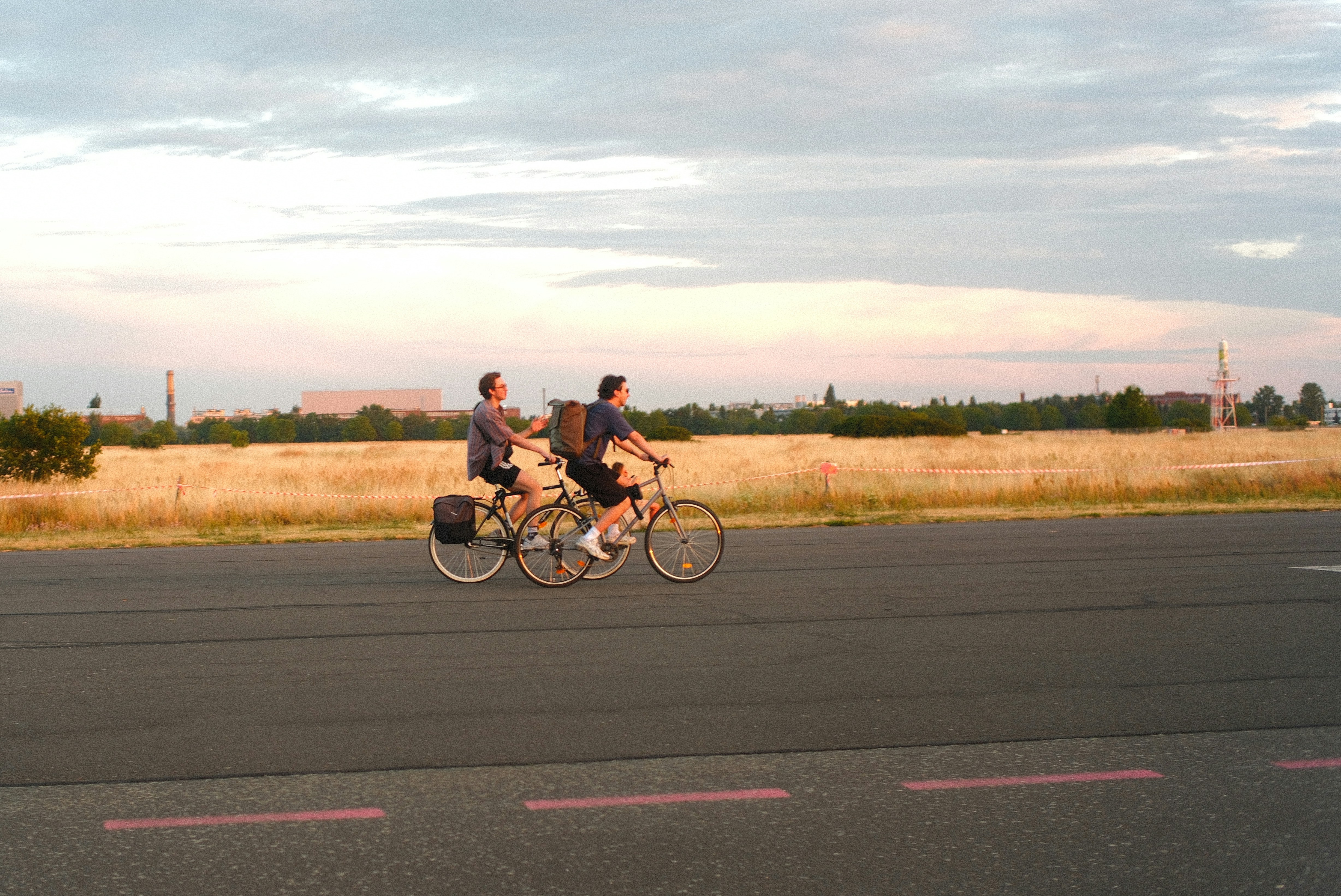 Twin Cyclists in a Golden Field