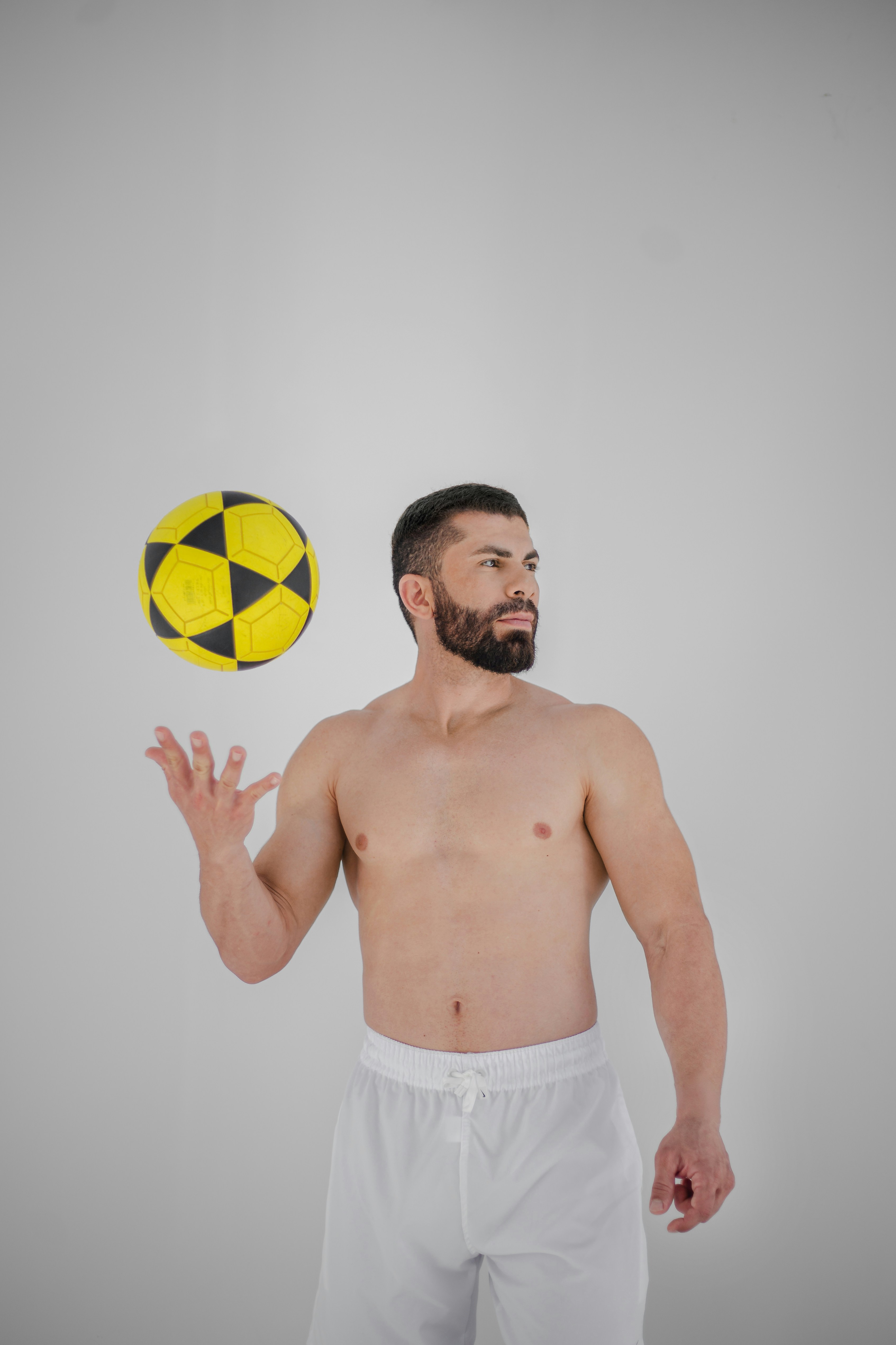 Floating Focus: Hands and Ball Align in Studio Stillness