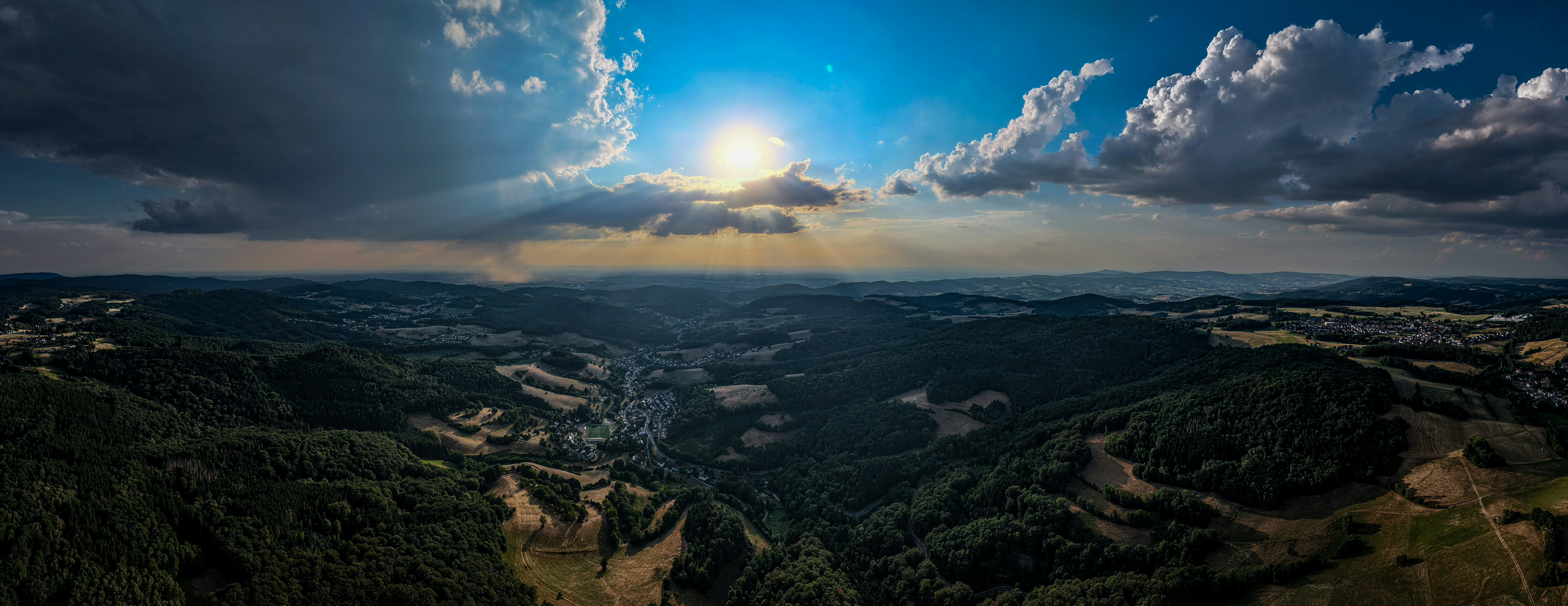 Sunlit Valley Panorama Over Rolling Hills at Dusk