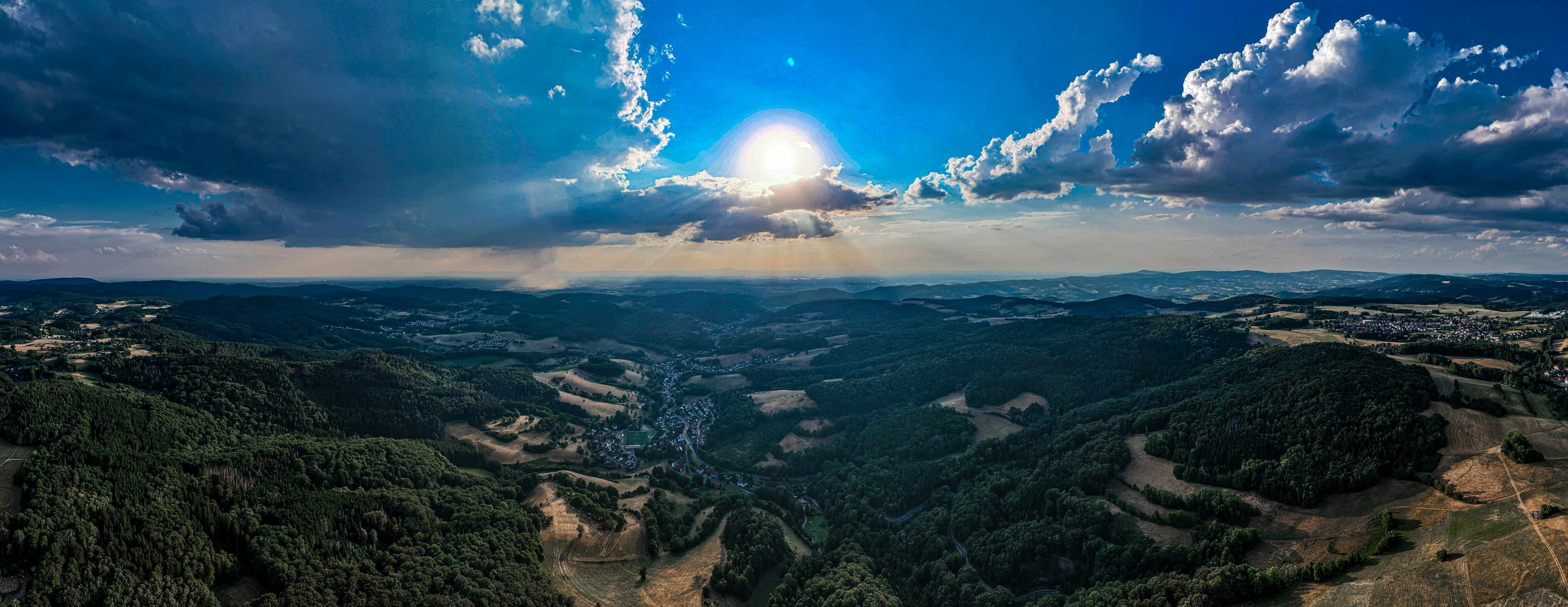Sunlit Crest: A Panoramic Riverbend from Above