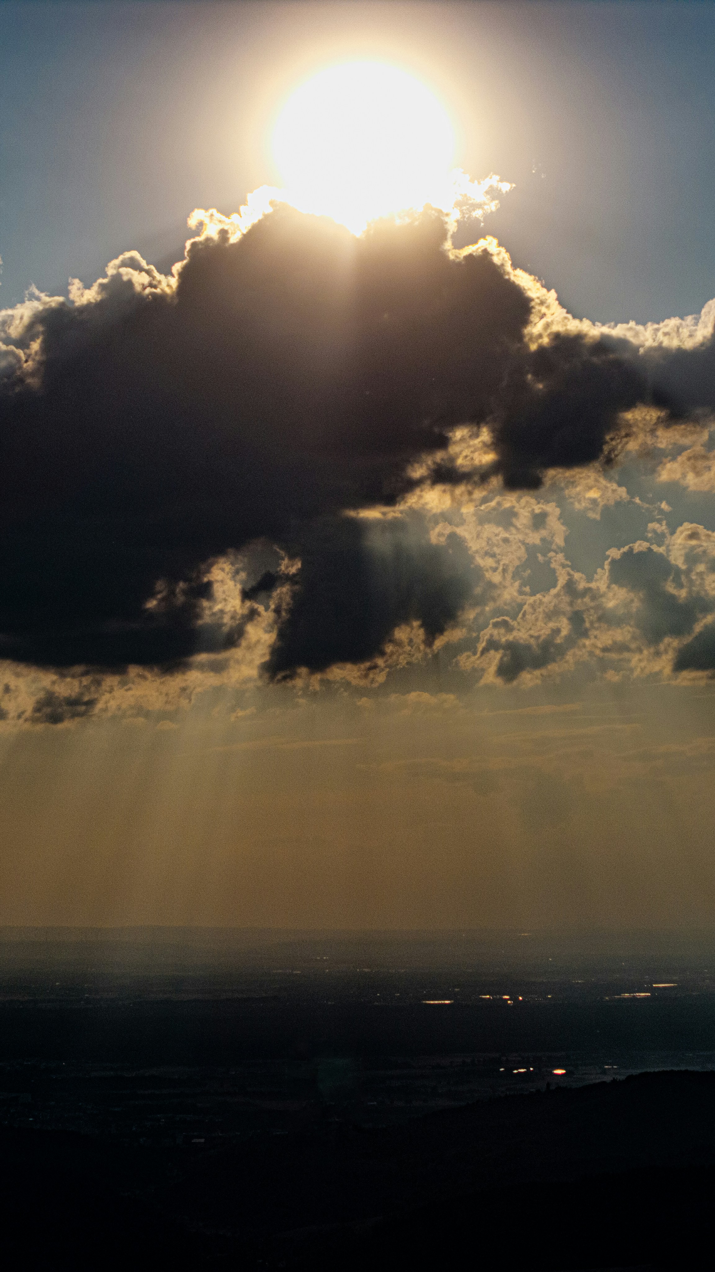 Sunburst Above the Cloudbank: A Mountain Silhouette at Dusk