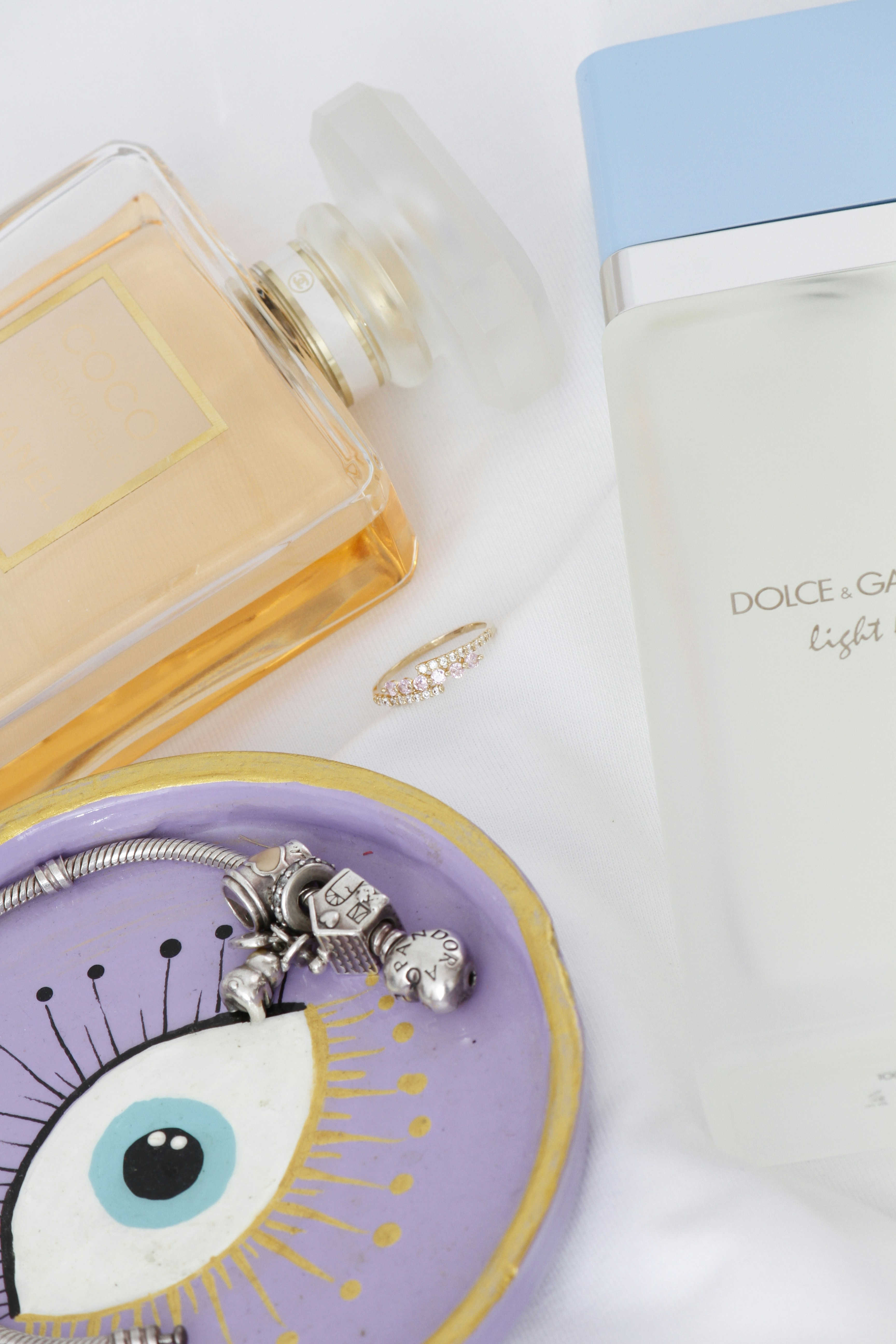 Glimmers of Glamour: a still life of fragrance, jewelry, and whimsy
