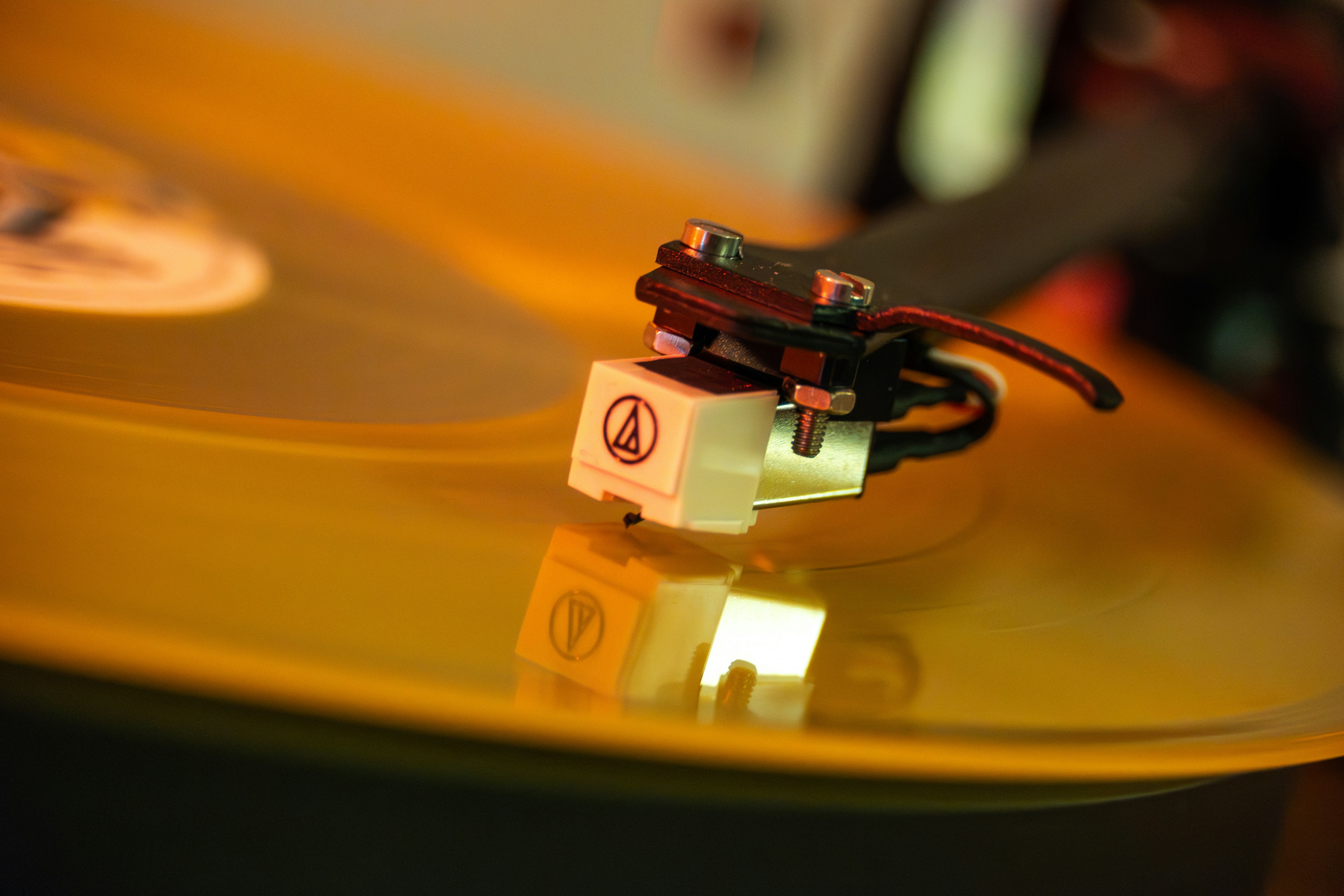 Floating Groove: A White Tonearm on a Glowing Vinyl