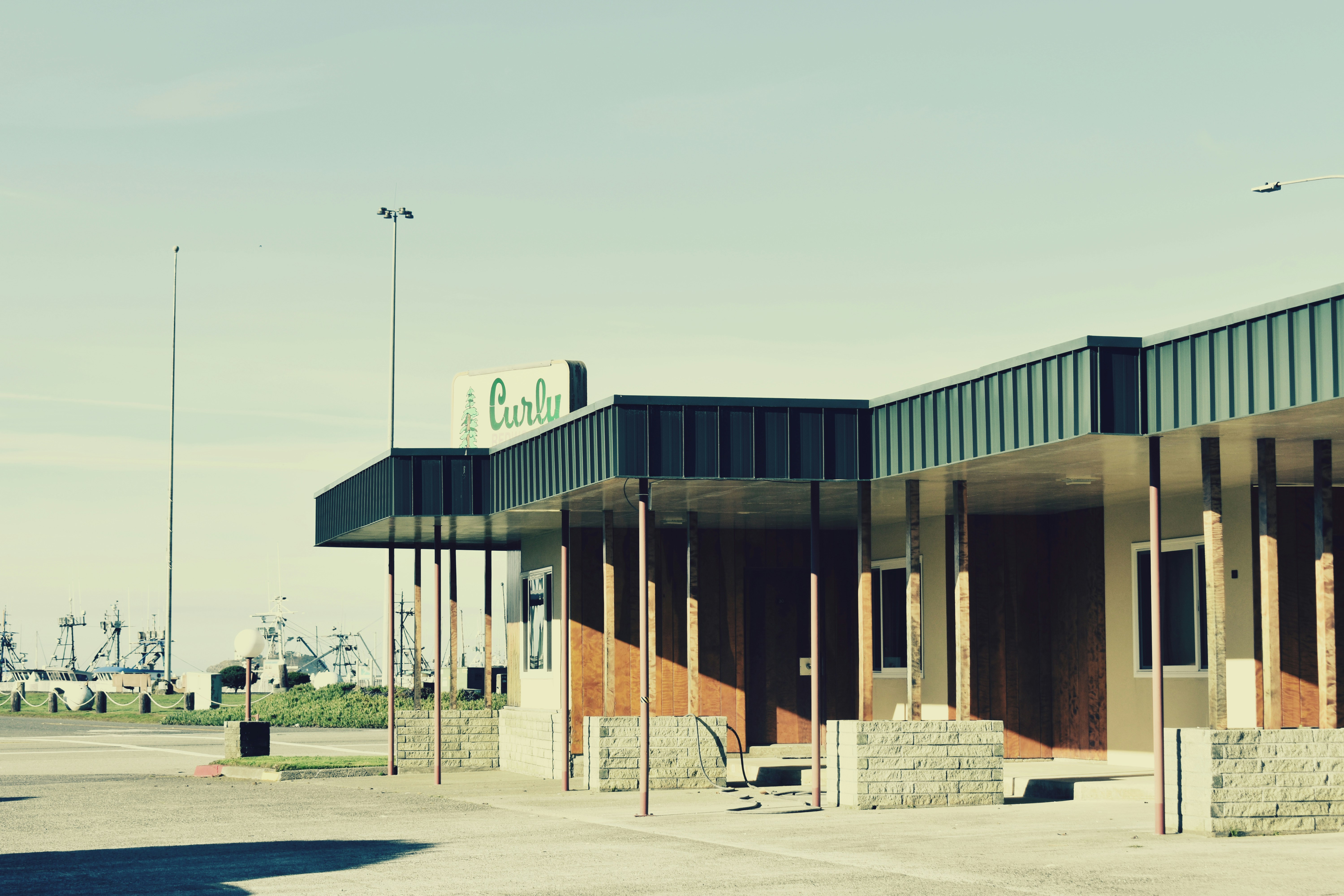 Abandoned Strip Mall Facade Beneath Open Sky